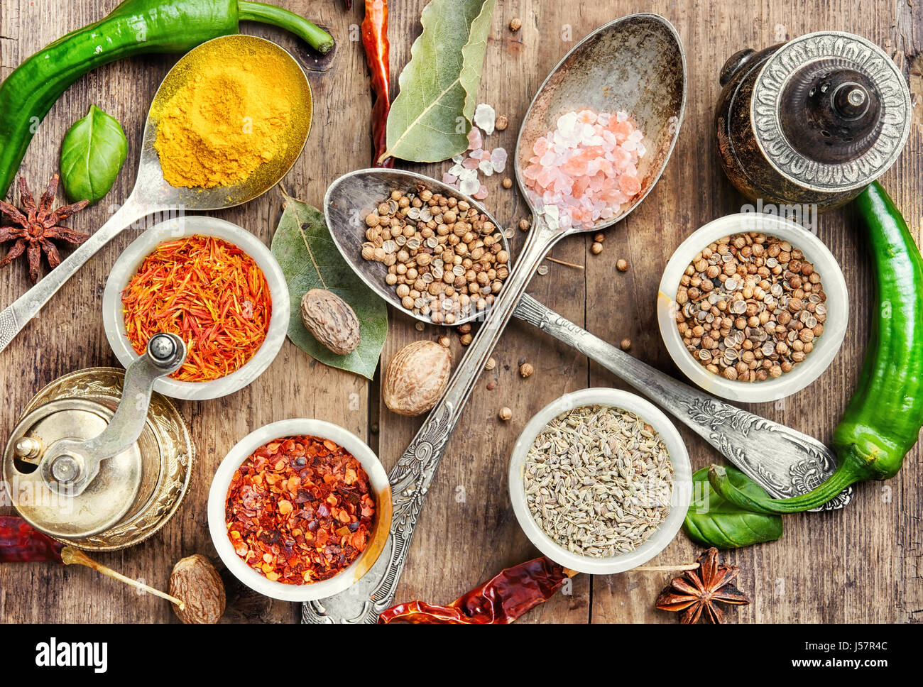 Variety of spices and seasonings on kitchen table Stock Photo - Alamy