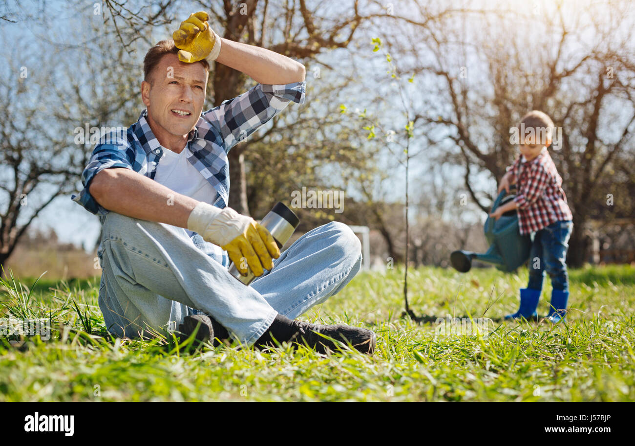 Father and son working in yard together Stock Photo - Alamy