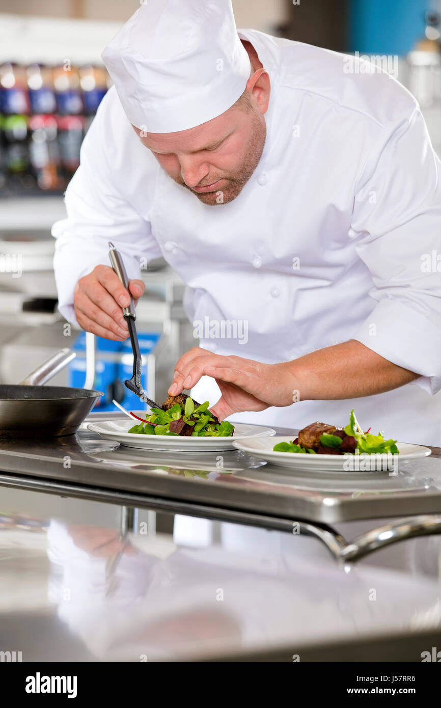 Professional chef prepare steak dish at restaurant Stock Photo - Alamy