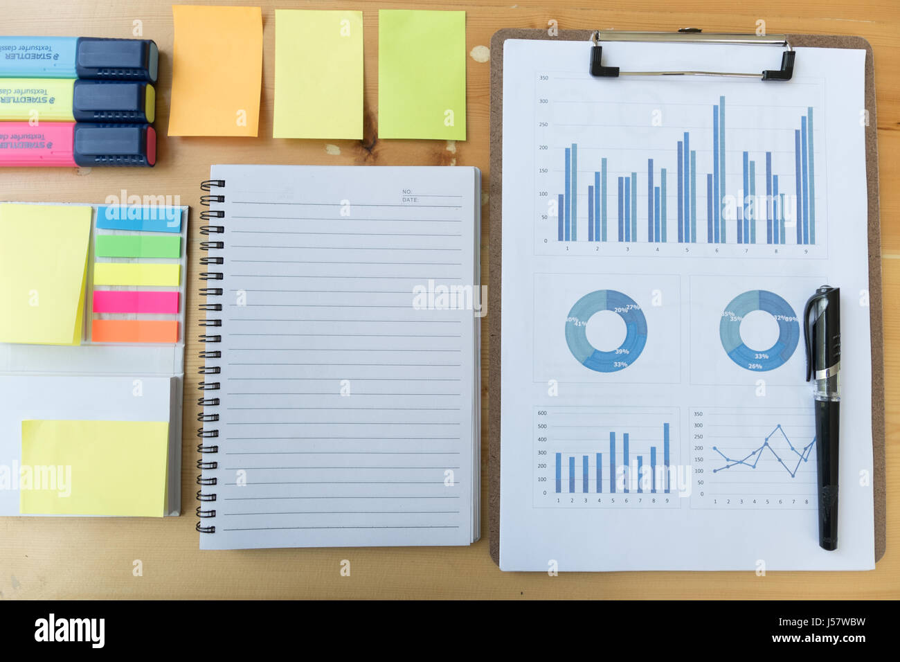marketing graph and chart report with highlighter, blank notebook ...