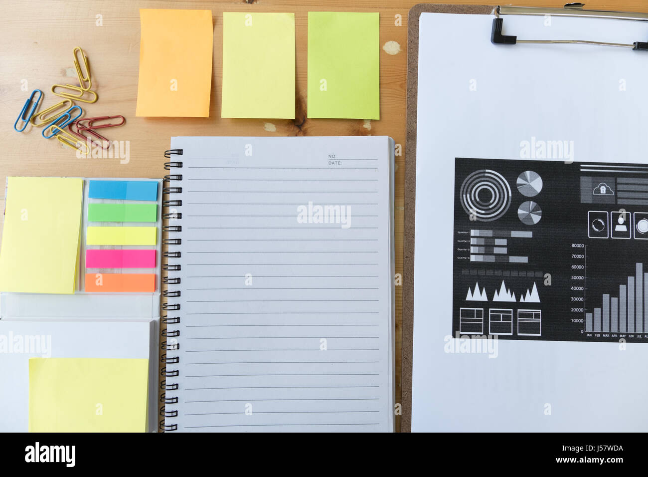 marketing graph and chart report with blank notebook, sticky note ...