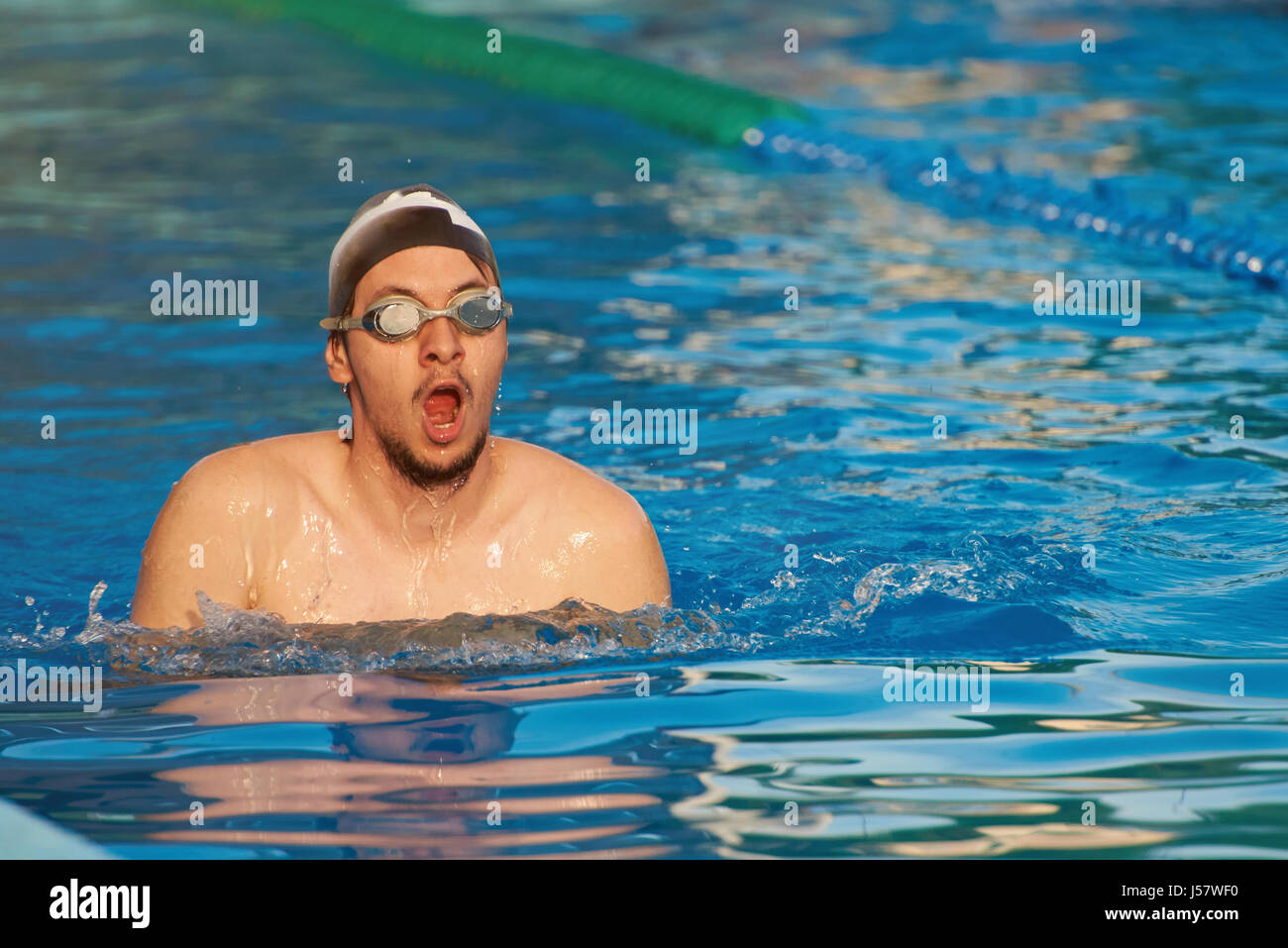 One young man swim in open pool front view Stock Photo - Alamy