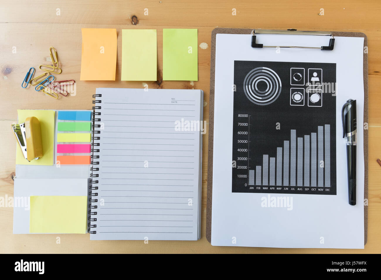marketing graph and chart report with pen, blank notebook, sticky note ...