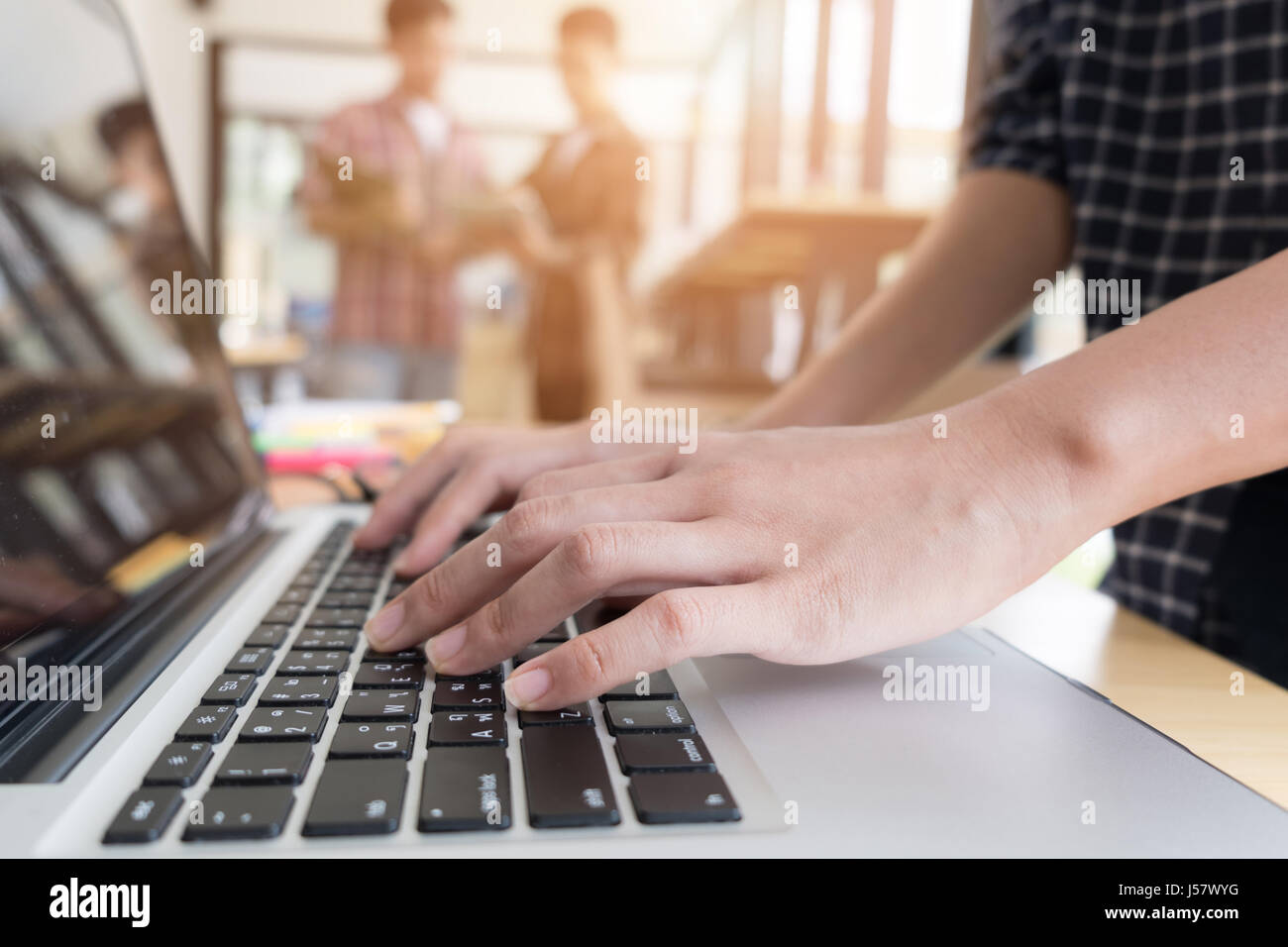 young university students studying with computer in cafe. Group of ...