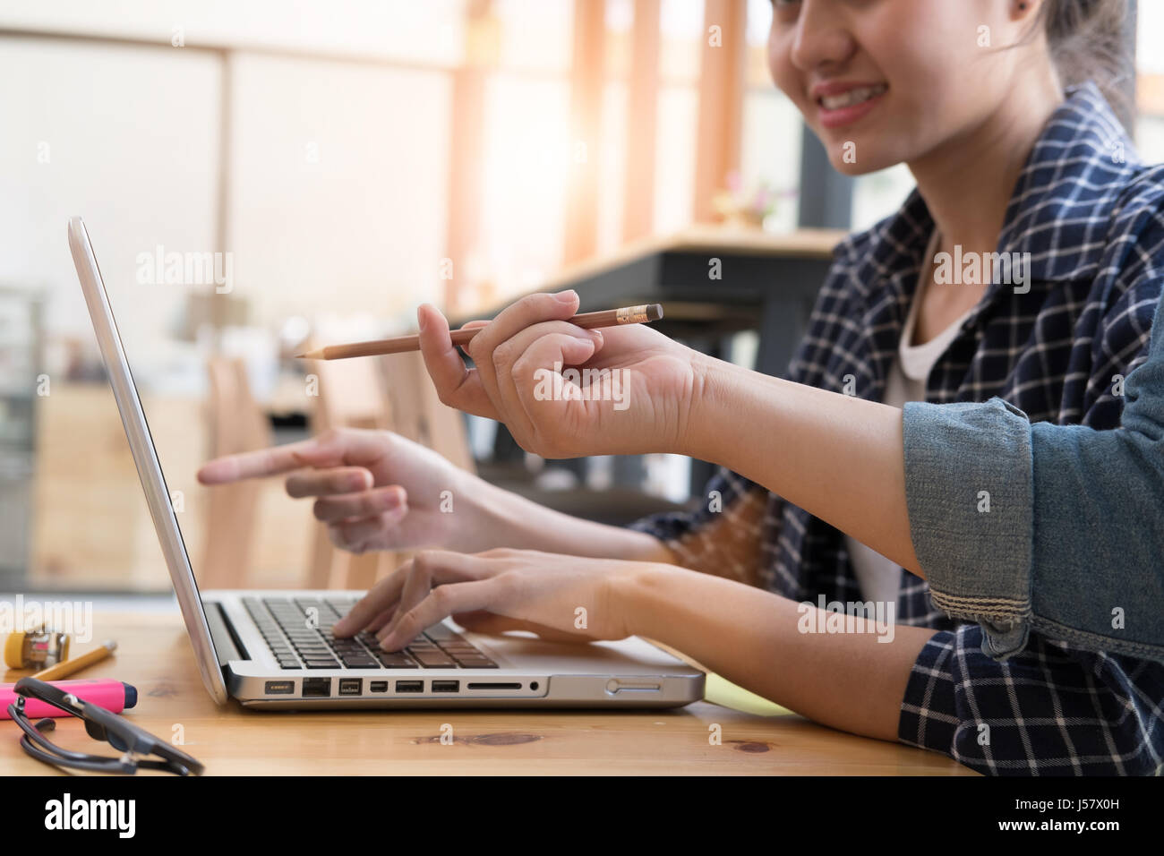 young university students studying with computer in cafe. Group of ...