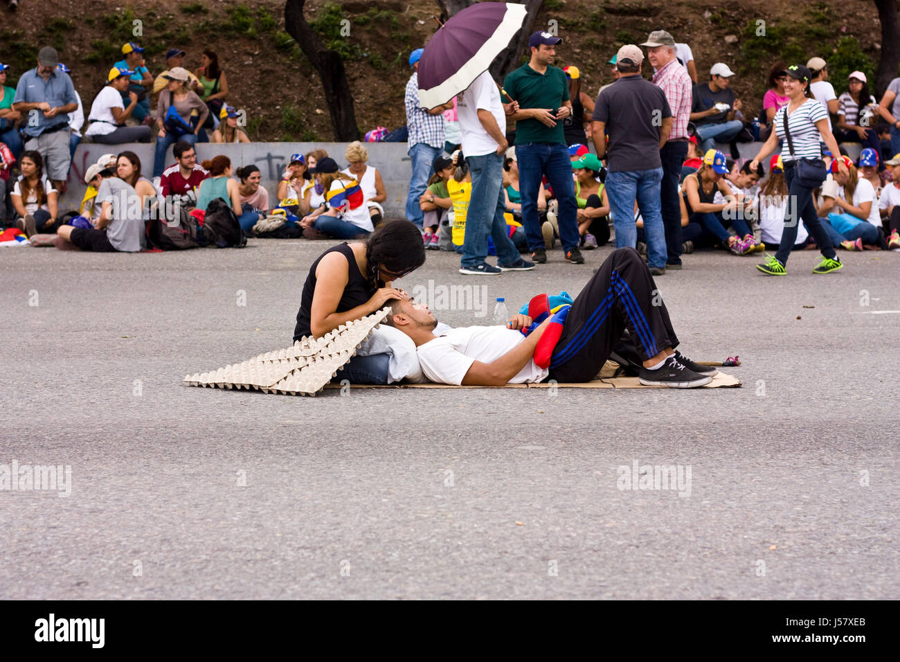 Two persons laying down in a highway during a protest Stock Photo - Alamy