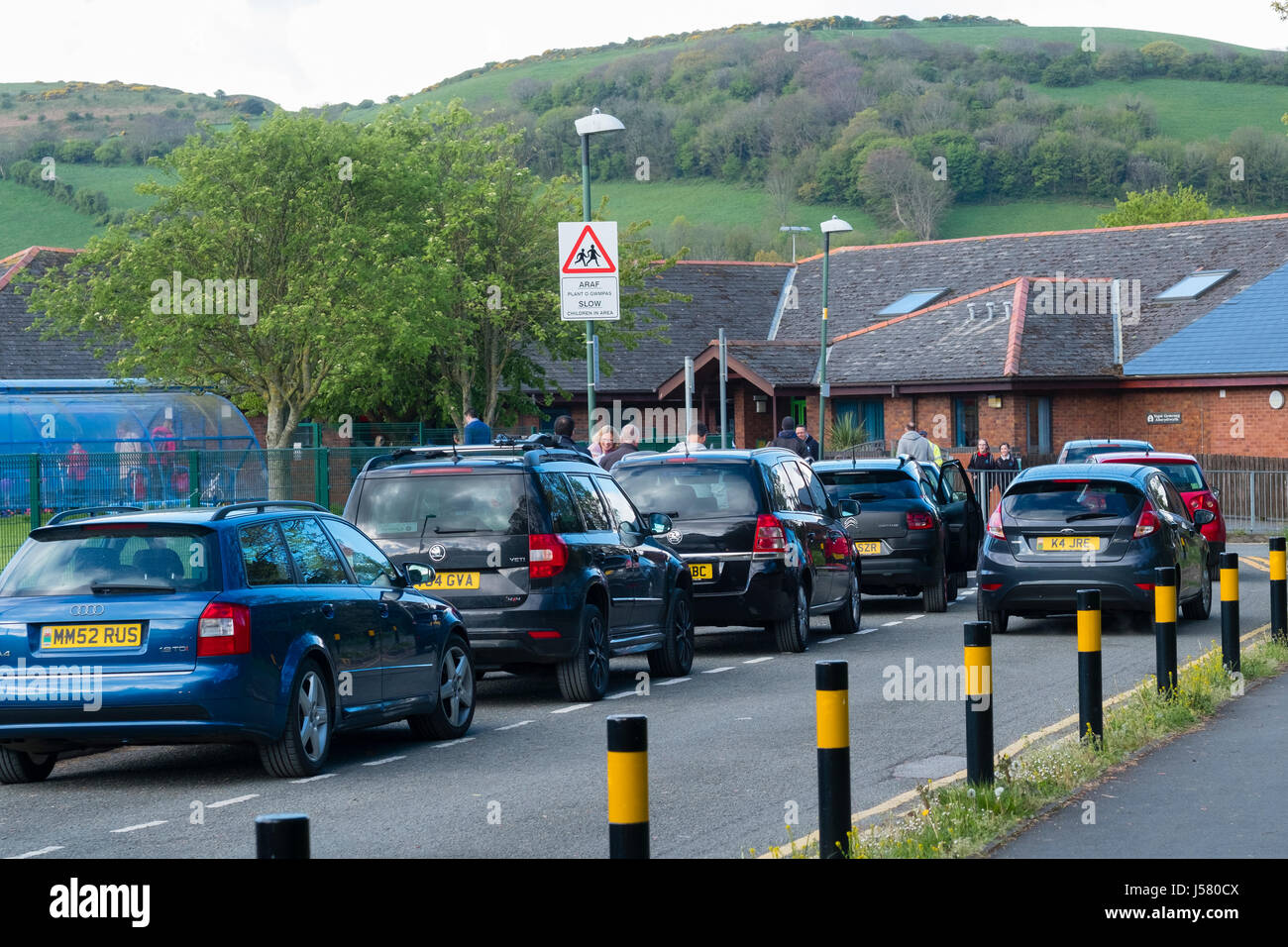 The school run: Rows of cars lined up outside a primary school as ...