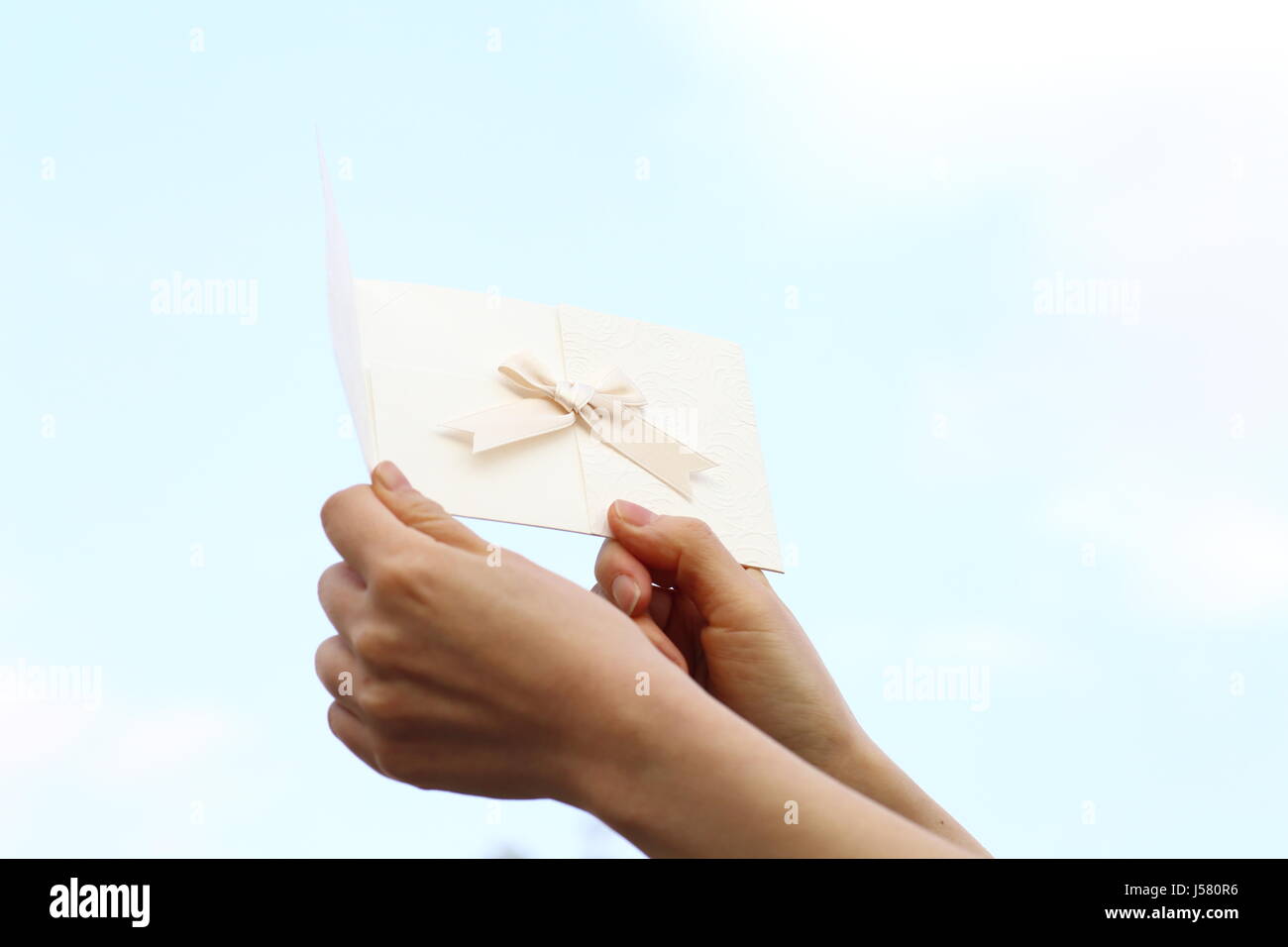 Woman Hand Holding Invitation Card Stock Photo - Alamy