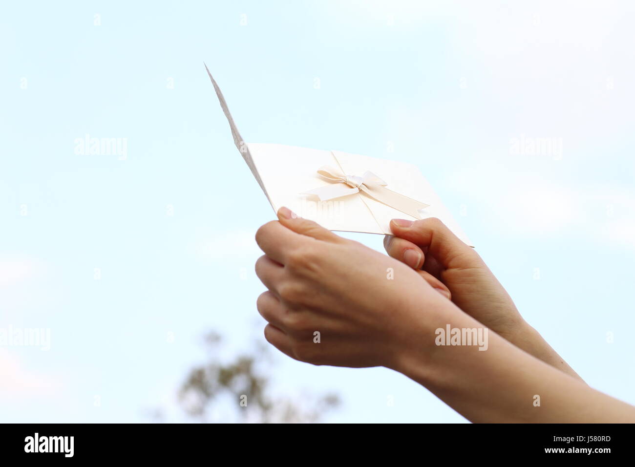 Woman Hand Holding Invitation Card Stock Photo - Alamy