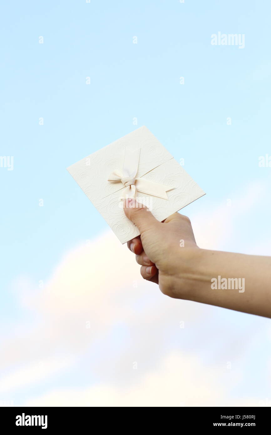 Woman Hand Holding Invitation Card Stock Photo - Alamy