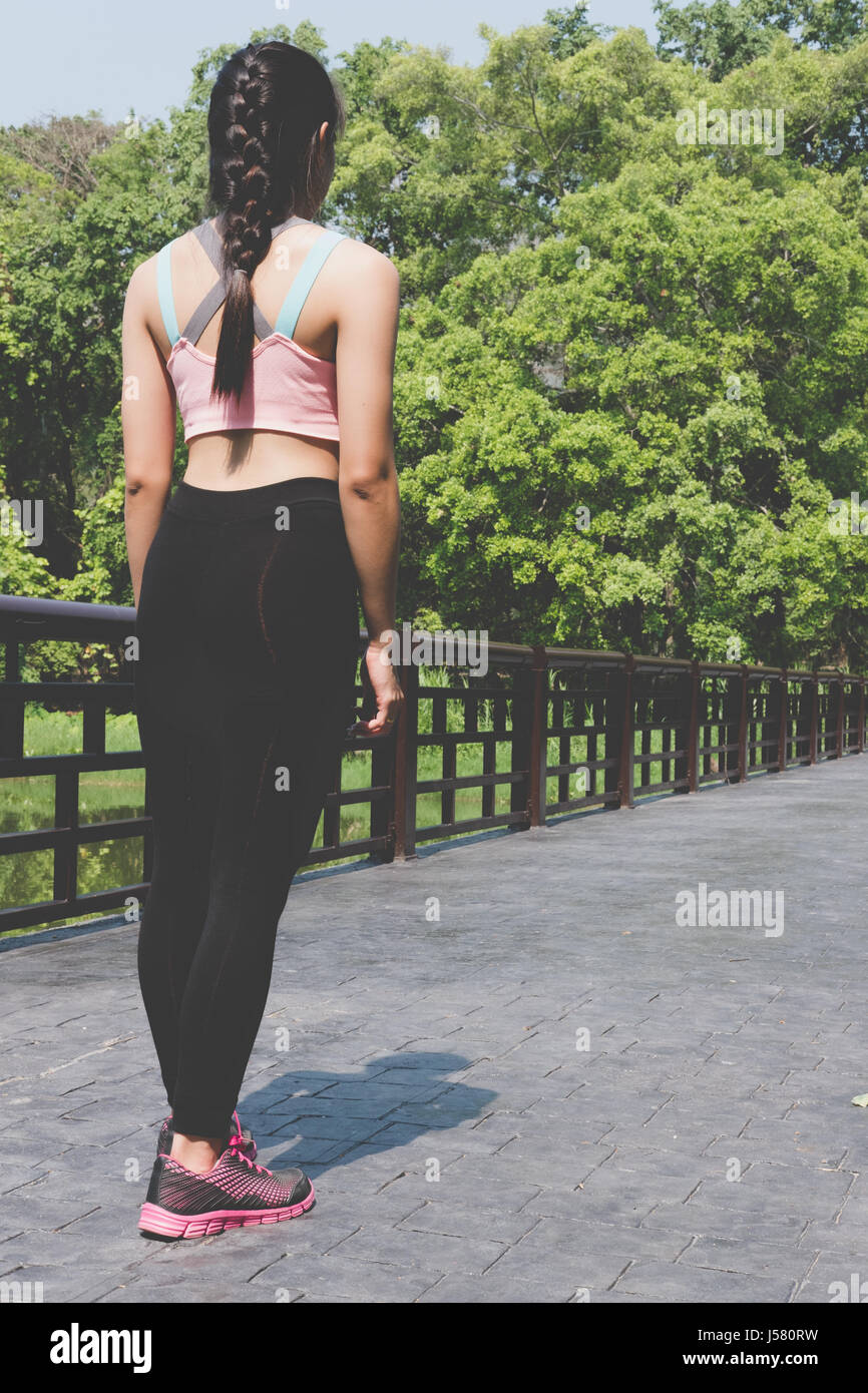 Female sport fitness athlete runner standing before jogging outdoors on ...