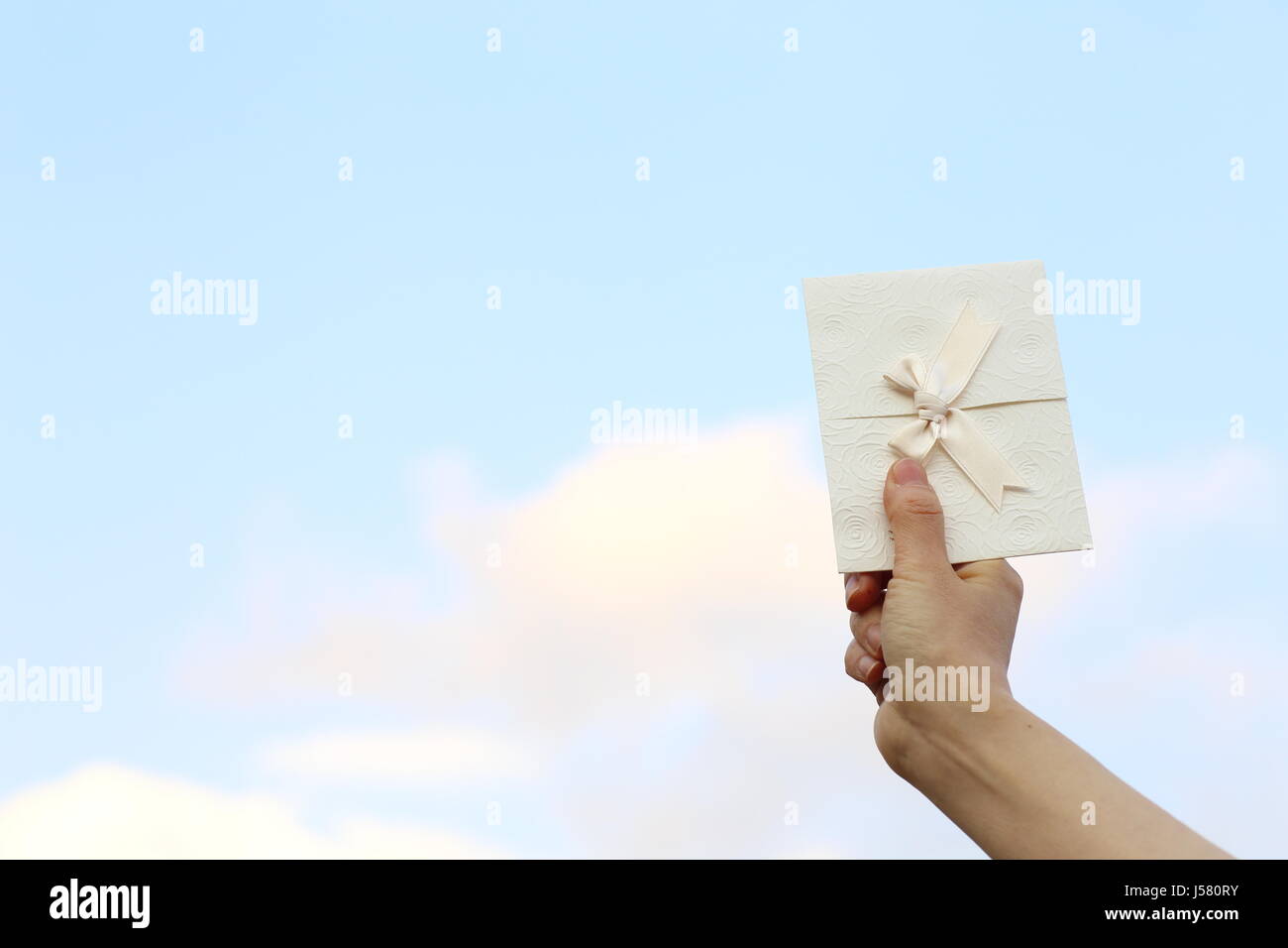 Woman Hand Holding Invitation Card Stock Photo - Alamy
