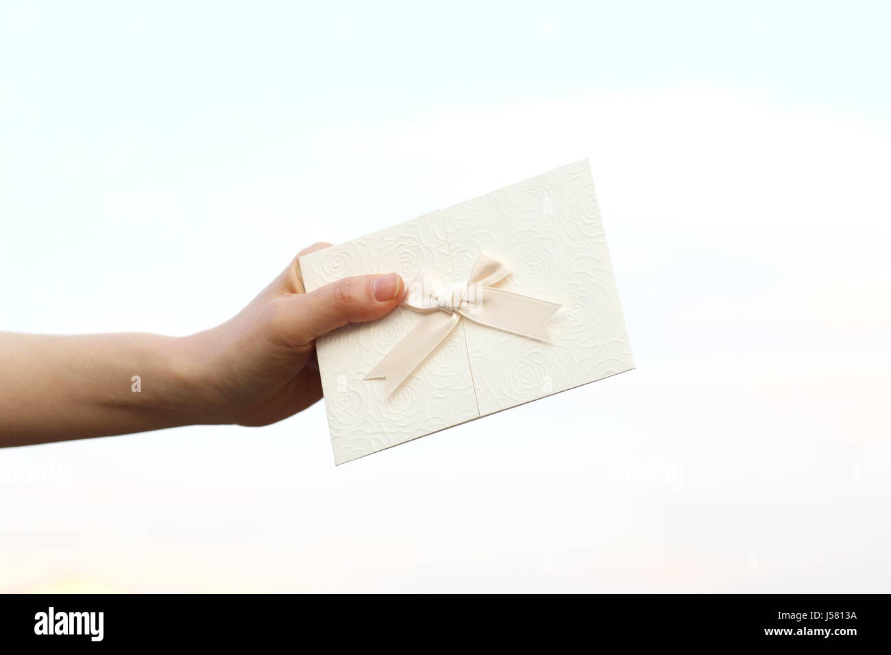 Woman Hand Holding Invitation Card Stock Photo - Alamy