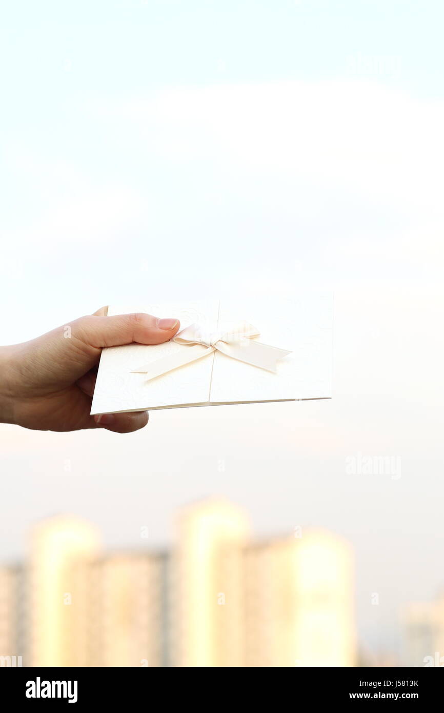 Woman Hand Holding Invitation Card Stock Photo - Alamy