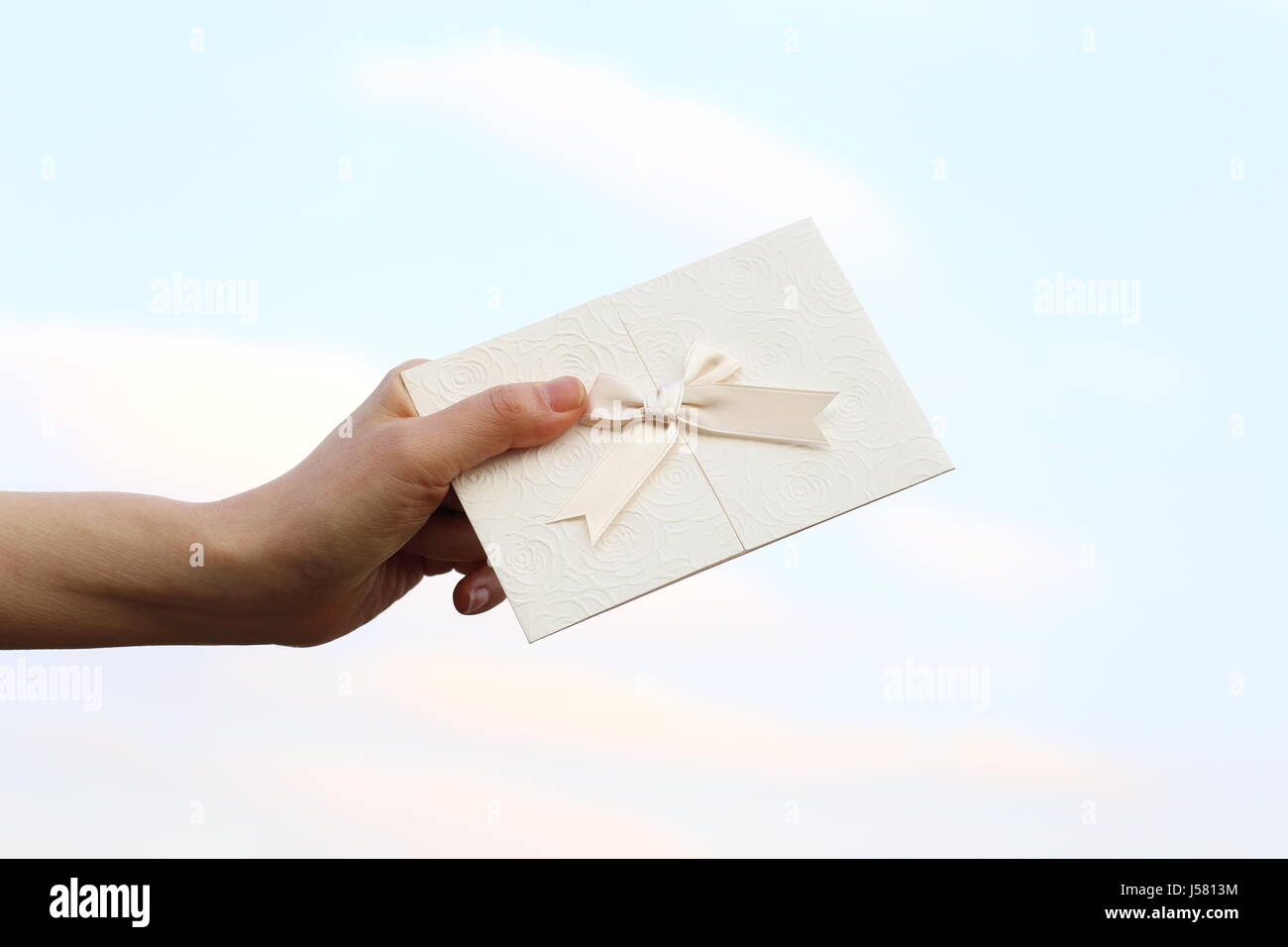 Woman Hand Holding Invitation Card Stock Photo - Alamy