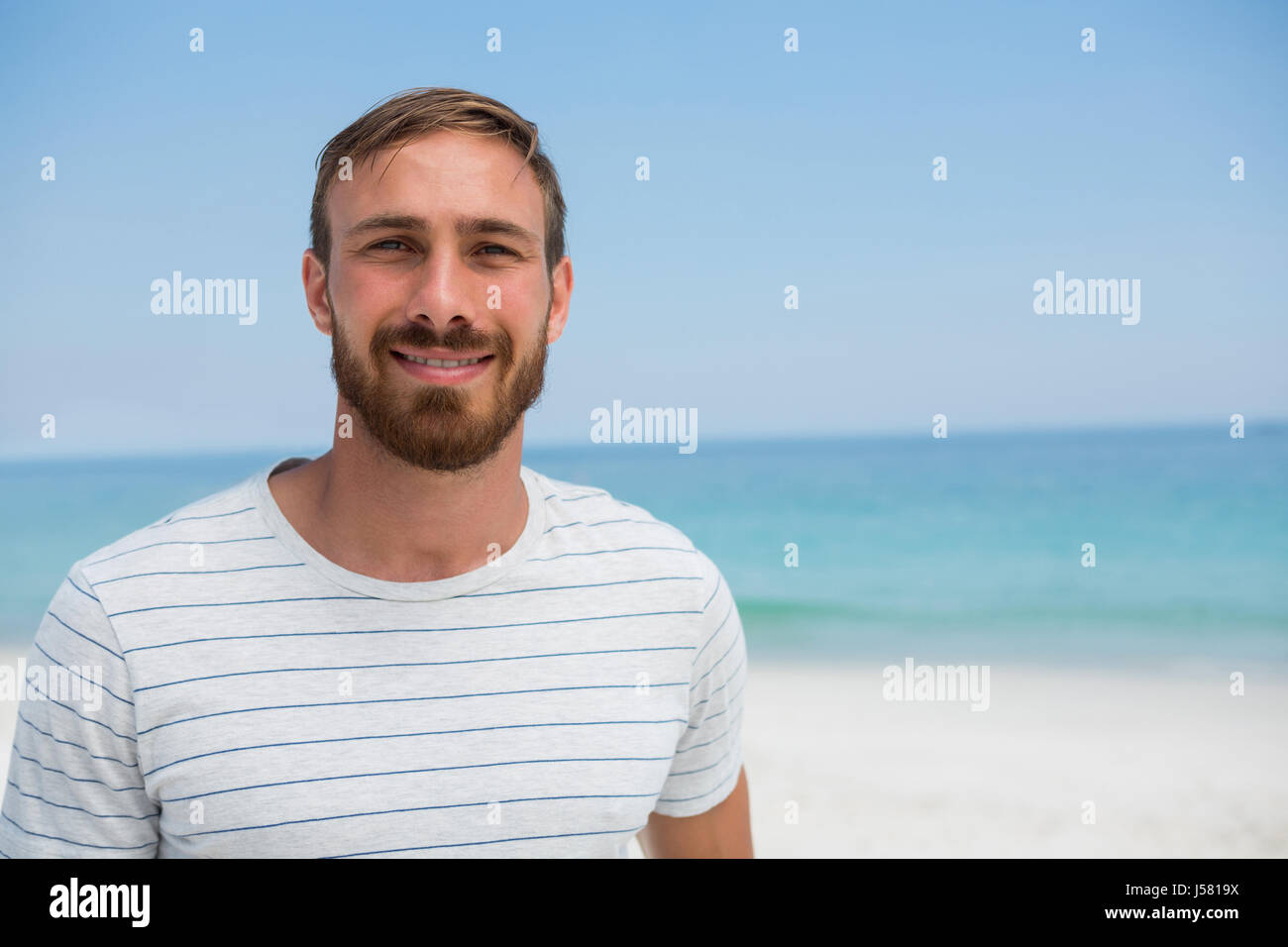 Close up portrait confident man standing at beach Stock Photo - Alamy