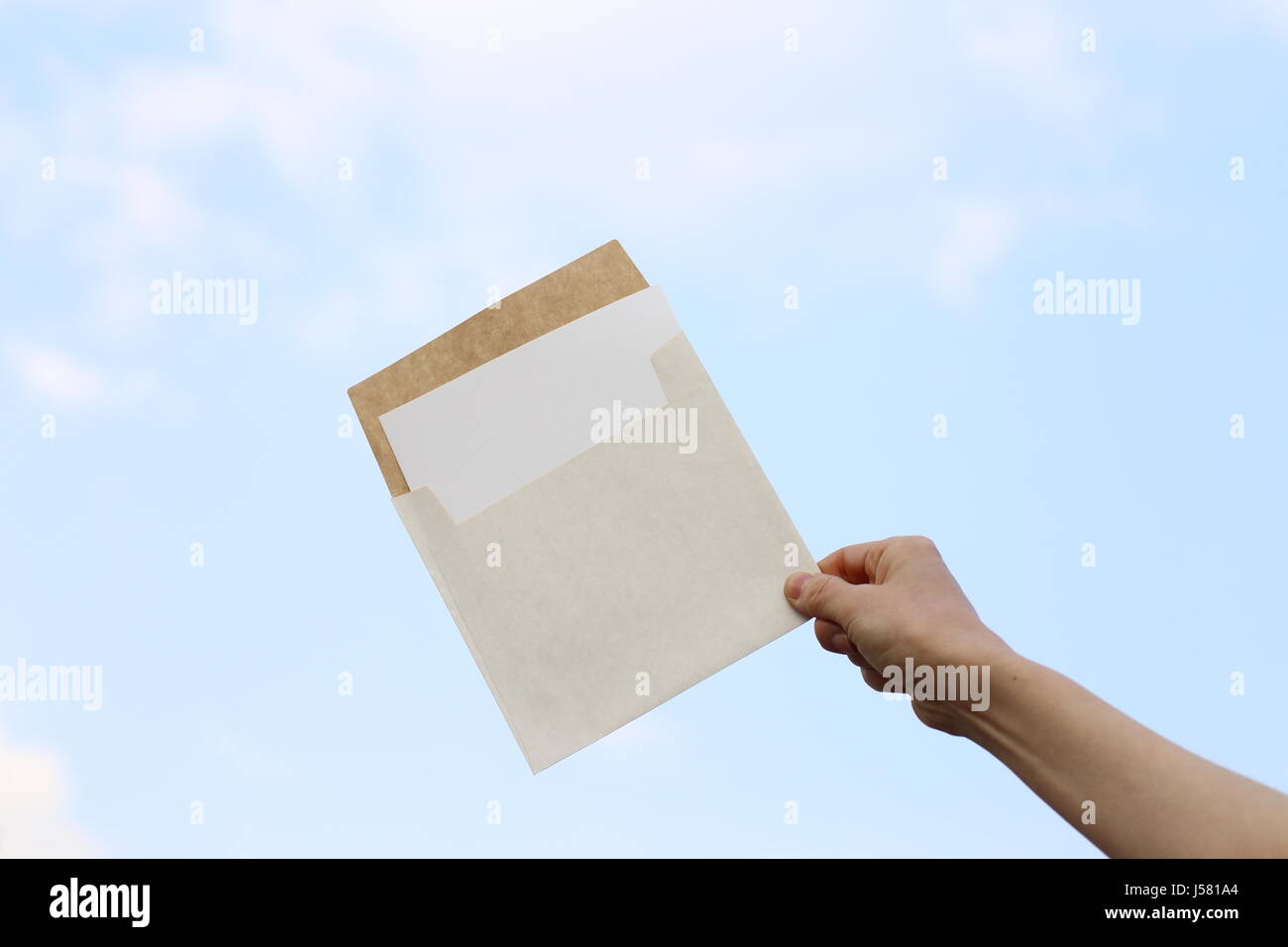 Woman Hand Holding Envelope Stock Photo - Alamy