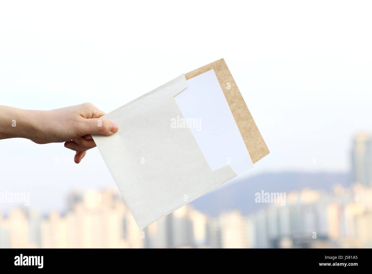 Woman Hand Holding Envelope Stock Photo - Alamy