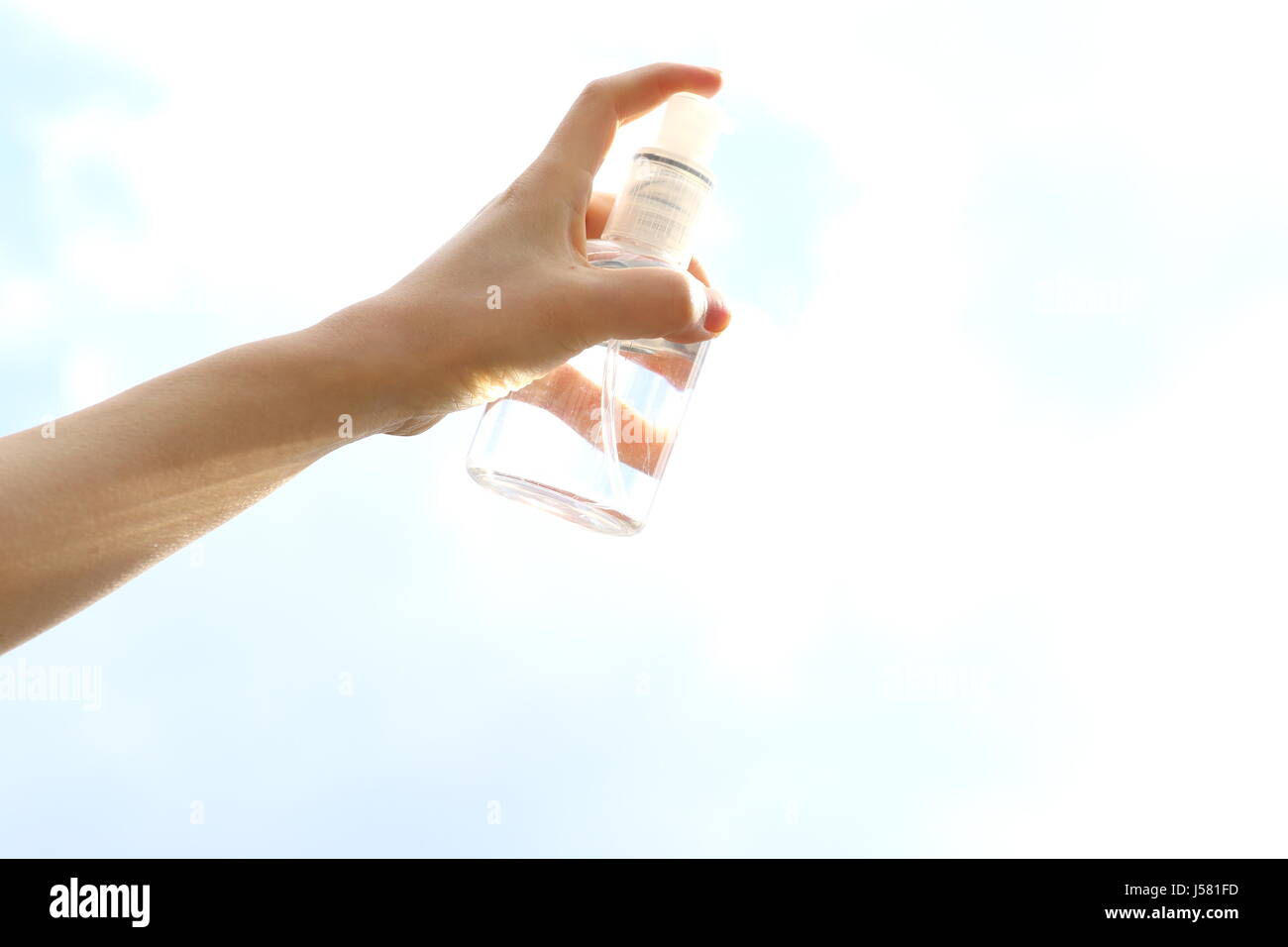 Woman Hand Holding Spray Stock Photo - Alamy