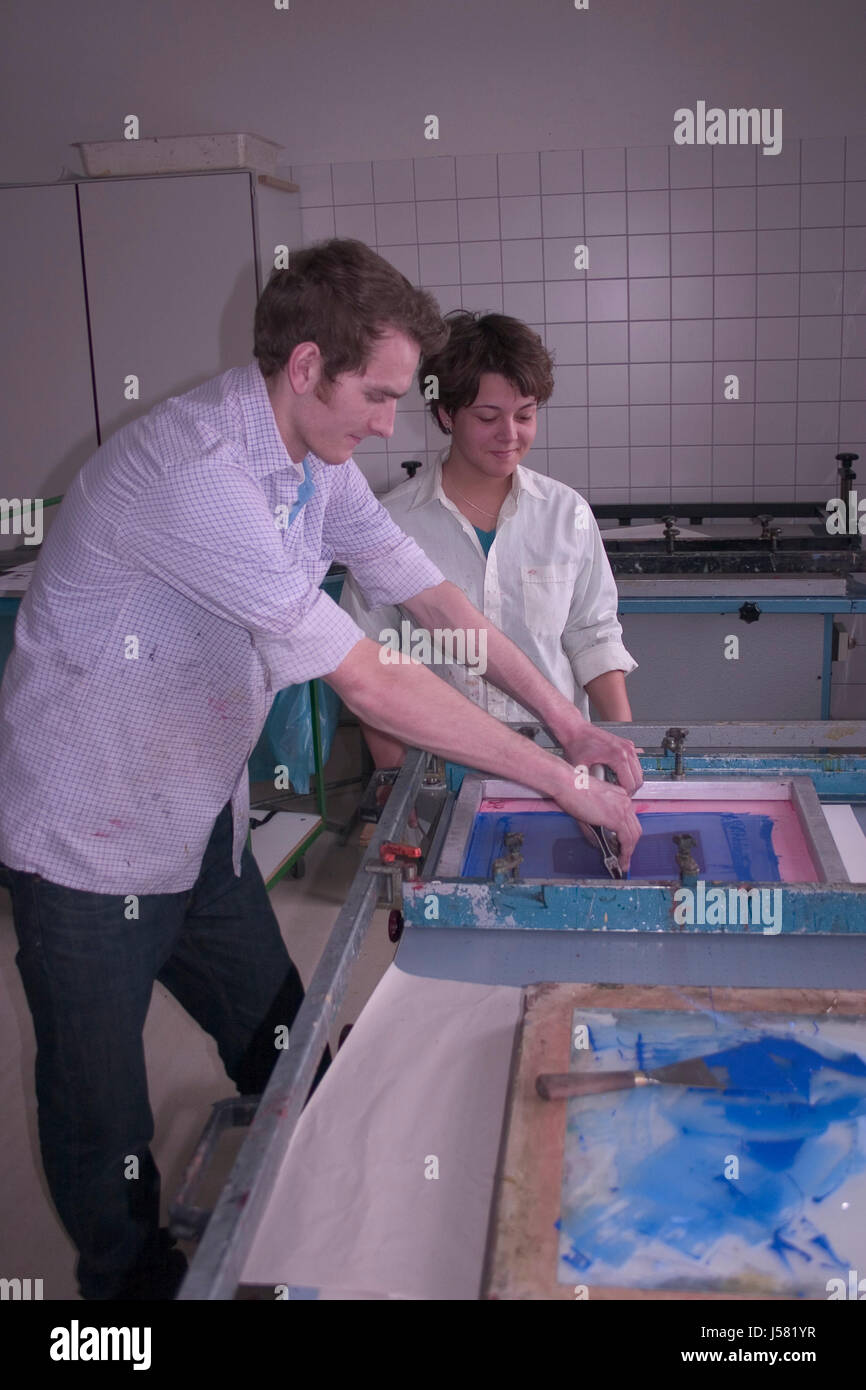 Man and woman silk screen printing hi-res stock photography and images ...