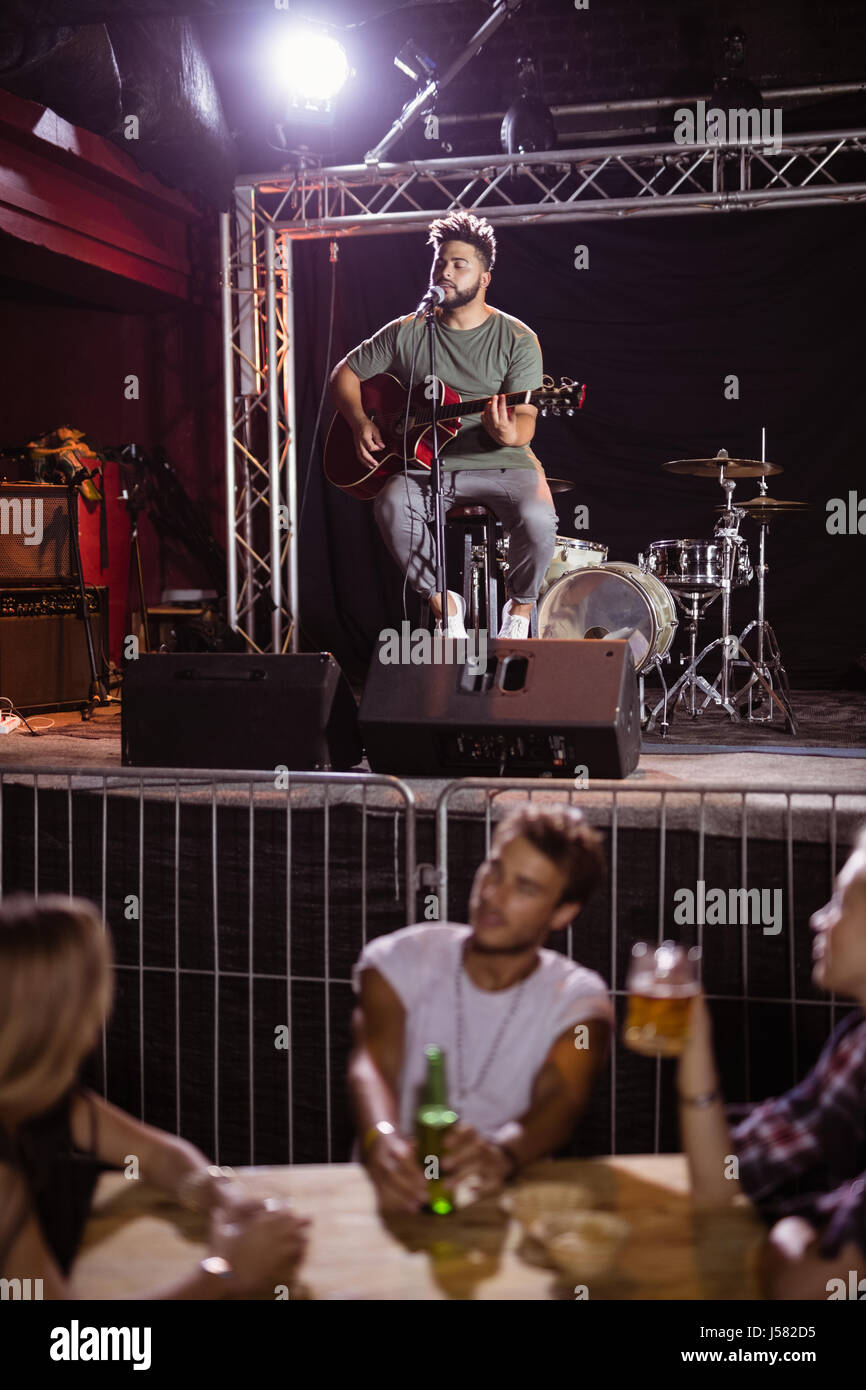 Playing guitar sitting on stool hi-res stock photography and images - Alamy
