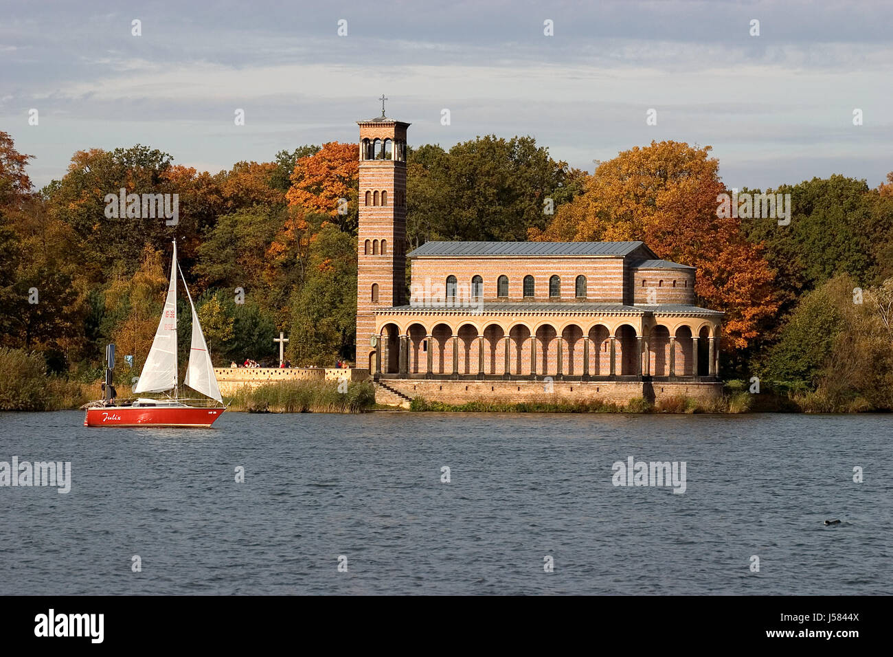 church tree trees waves sailing boat sailboat autumn foliage wind water ...