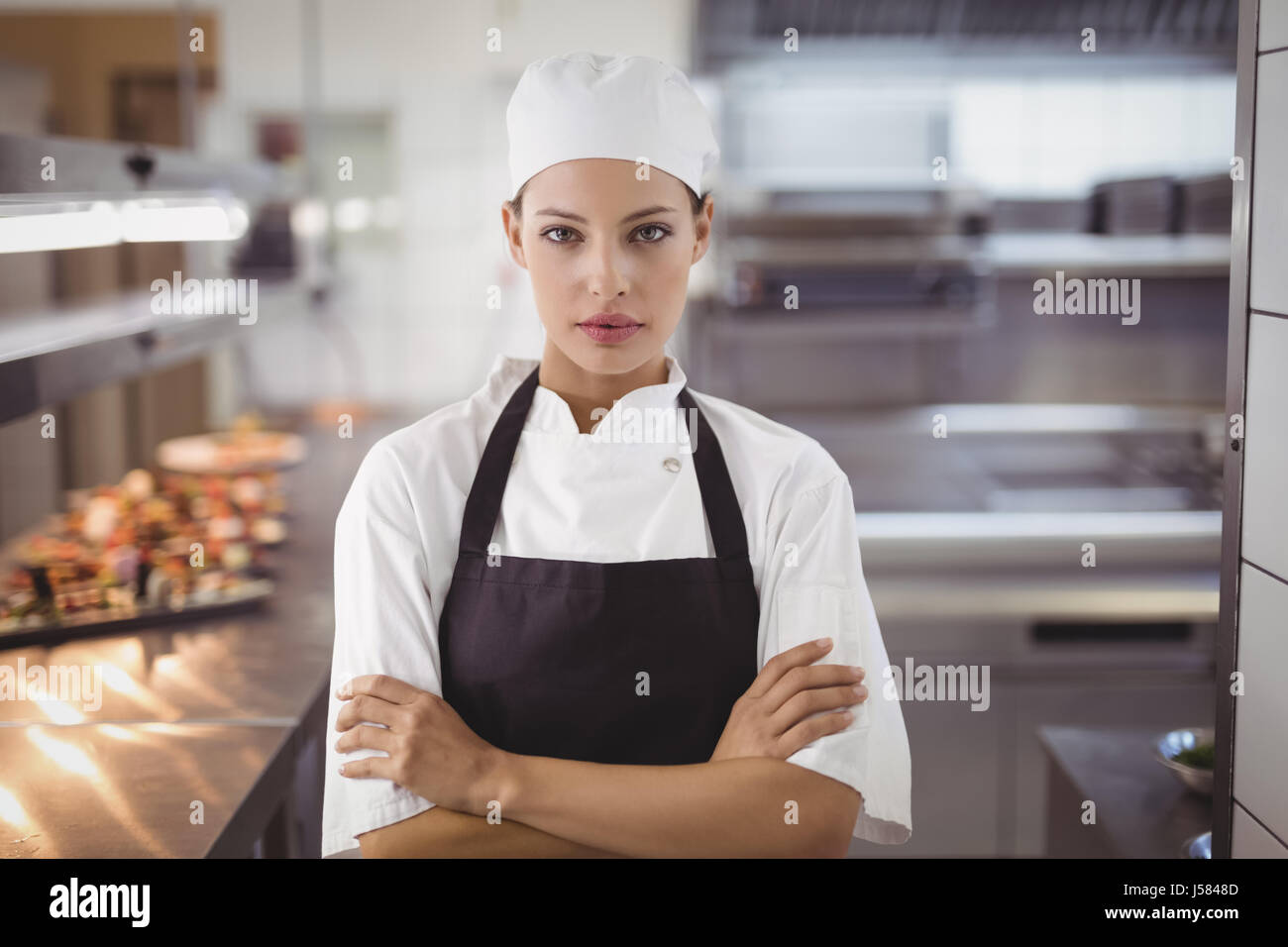 Portrait of female chef standing in the commercial kitchen Stock Photo ...
