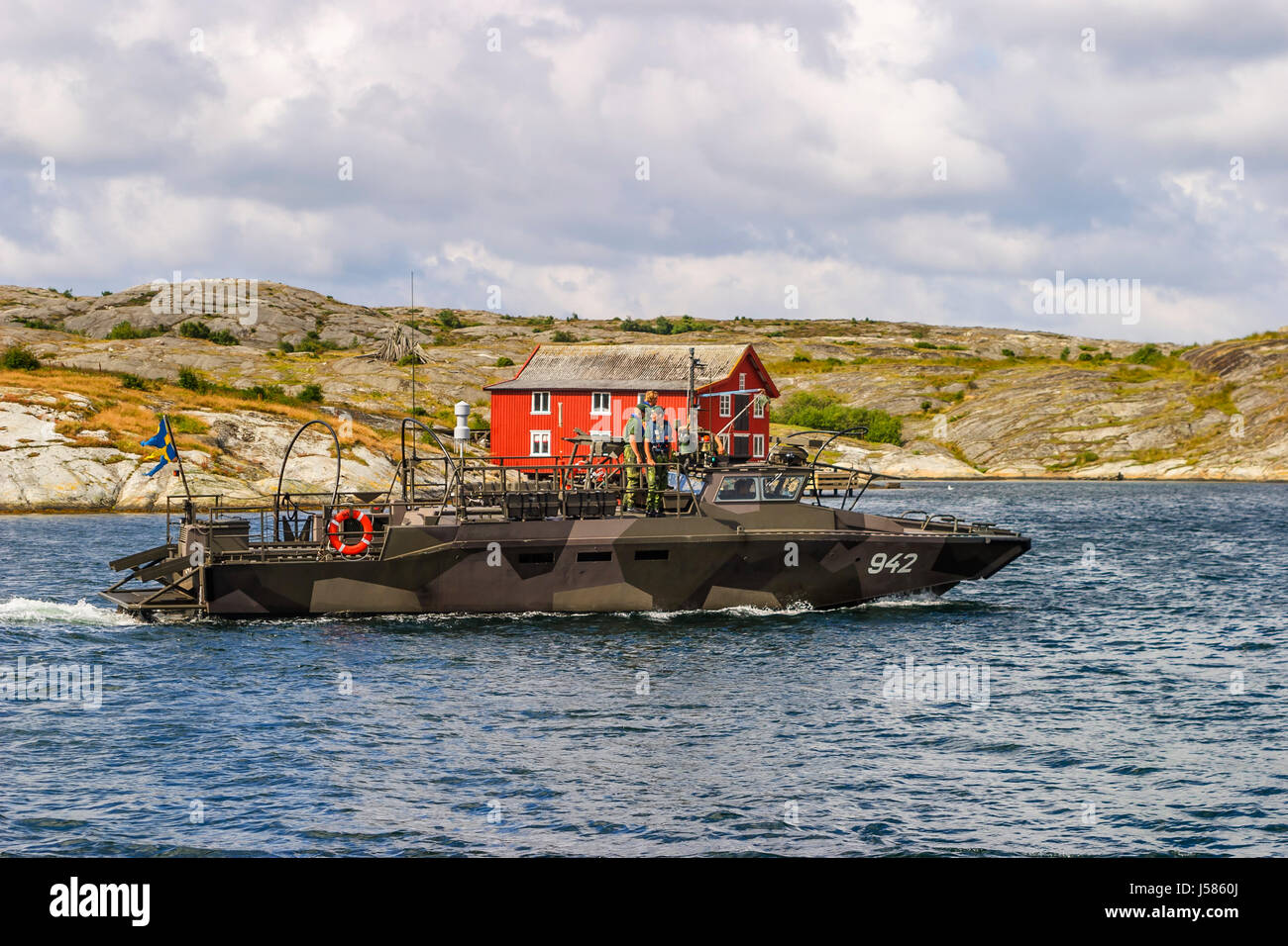 Navy ship in the rocky archipelago with sailors on deck Stock Photo - Alamy