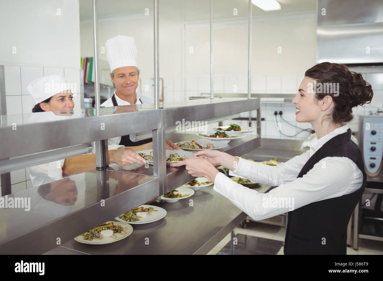 Handing food plate hi-res stock photography and images - Alamy