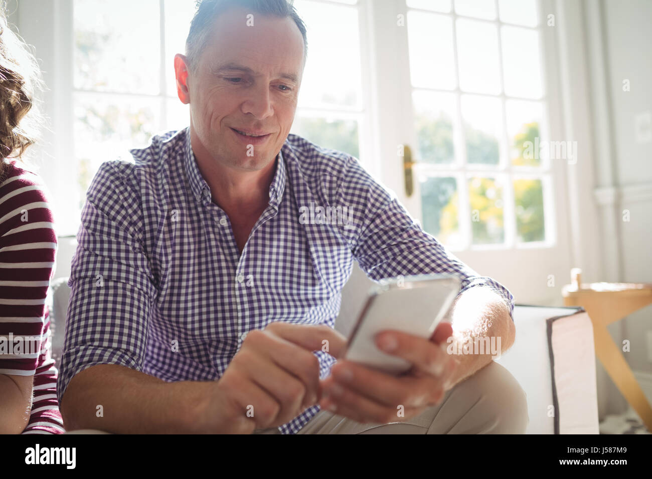 Happy man using mobile phone in restaurant Stock Photo - Alamy