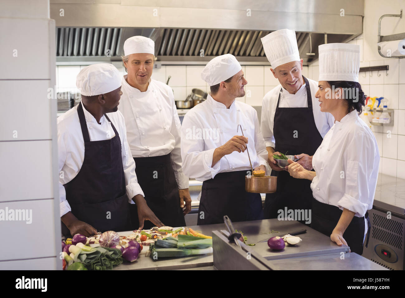 Team of chef tasting food in the commercial kitchen at restaurant Stock ...