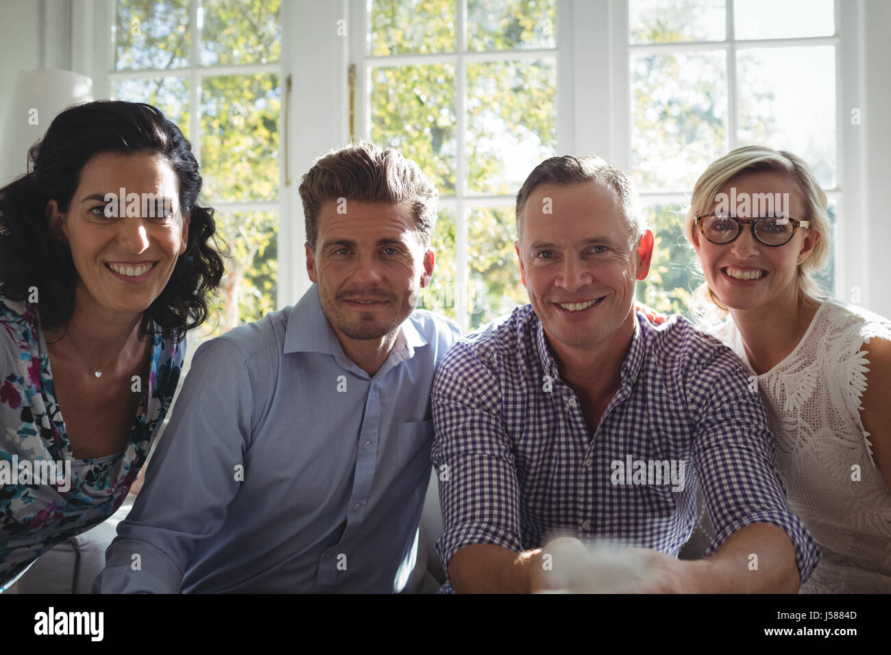 Group of friends sitting together at restaurant Stock Photo - Alamy