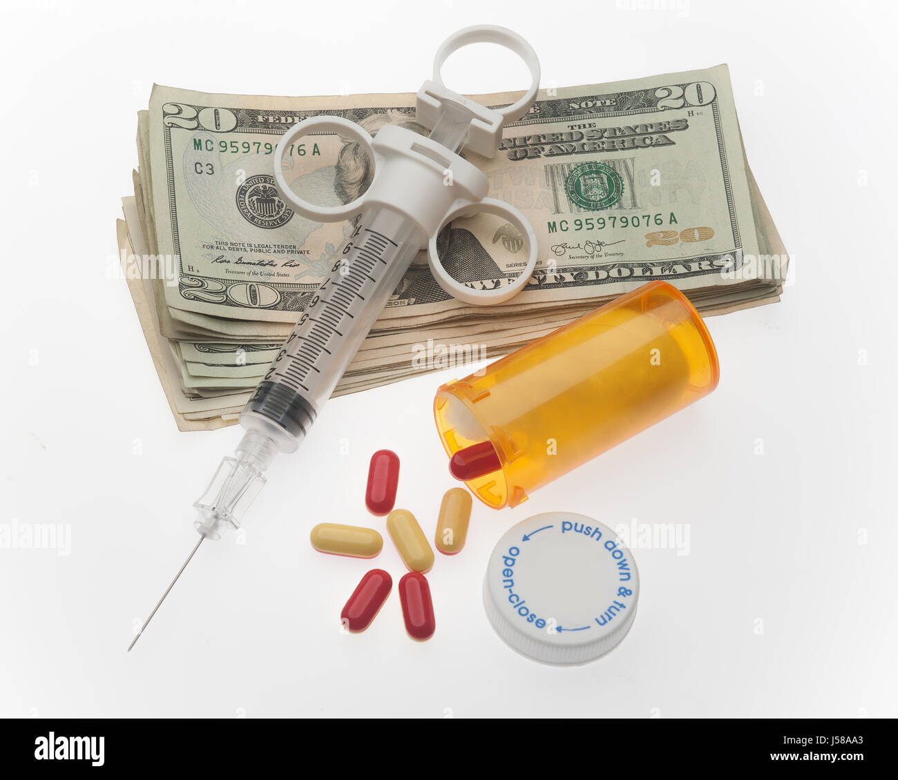 Cost of drug addiction concept with needle, money and drugs Stock Photo ...