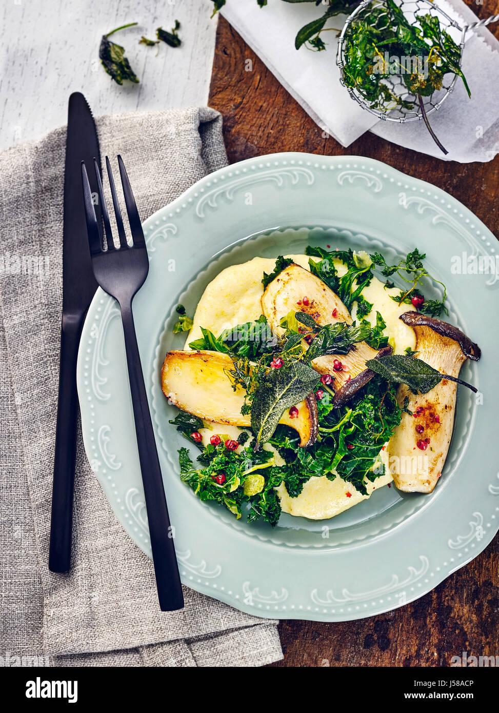 Creamy kale polenta with mushrooms and fried herbs Stock Photo - Alamy