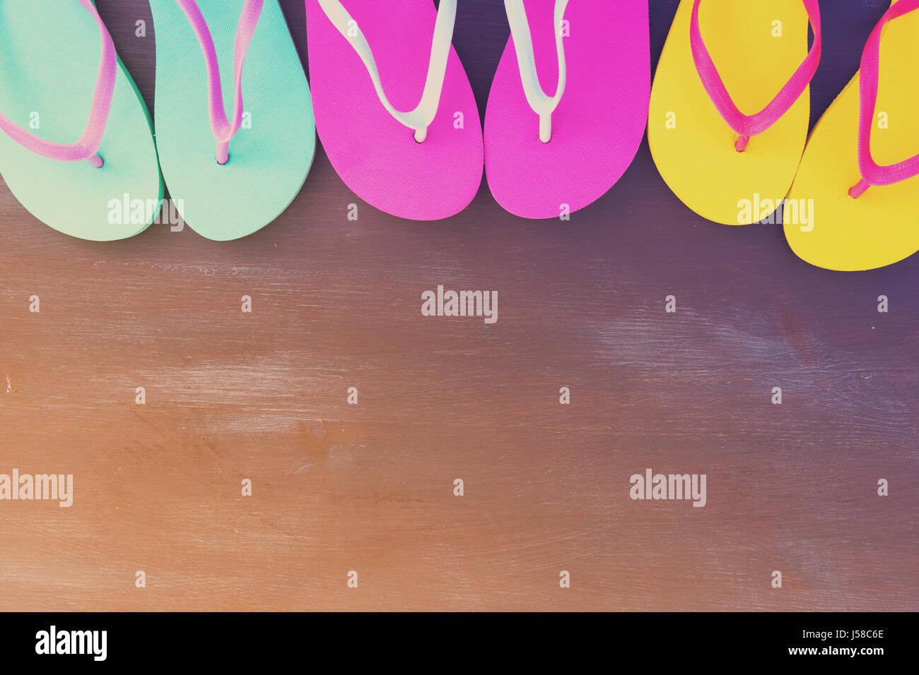 Summer beach fun - border of flip flop sandals, retro toned Stock Photo ...