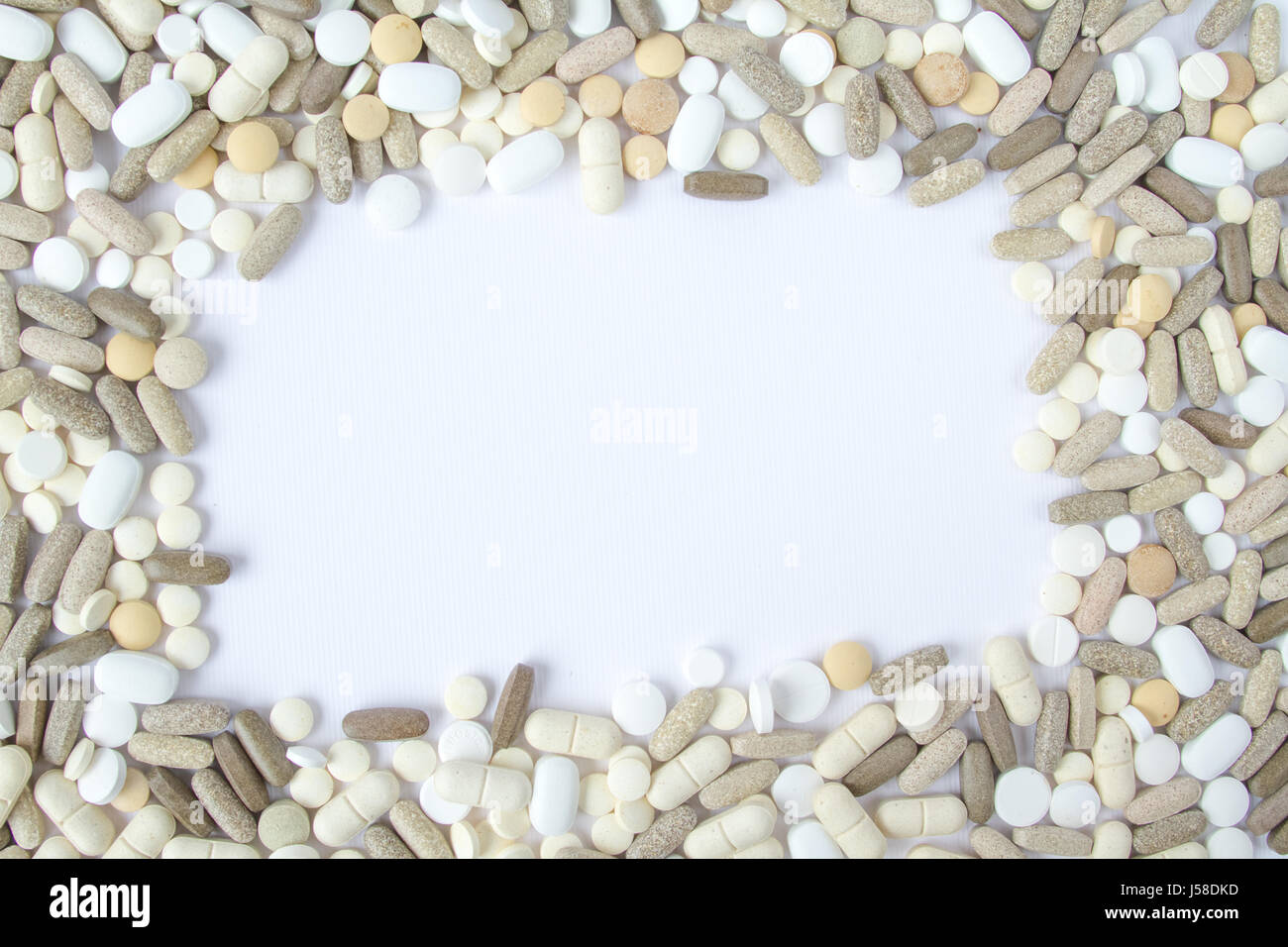 Colorful medical pills loose as frame on a white background. There is a ...