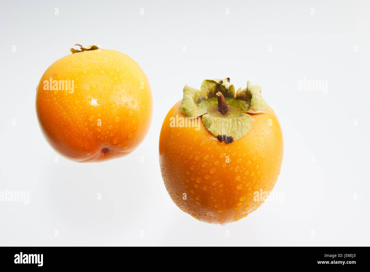 fruit exotic bright shiny tropical fruit smooth stalk orange hand kaki ...