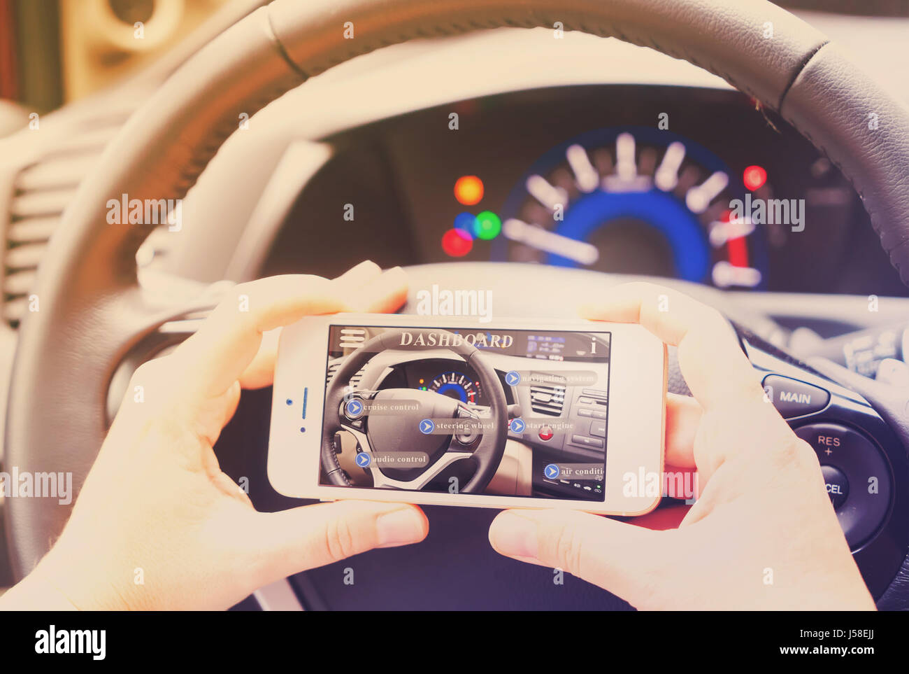 smart car concept - driving wheel and hands holding phone with ...