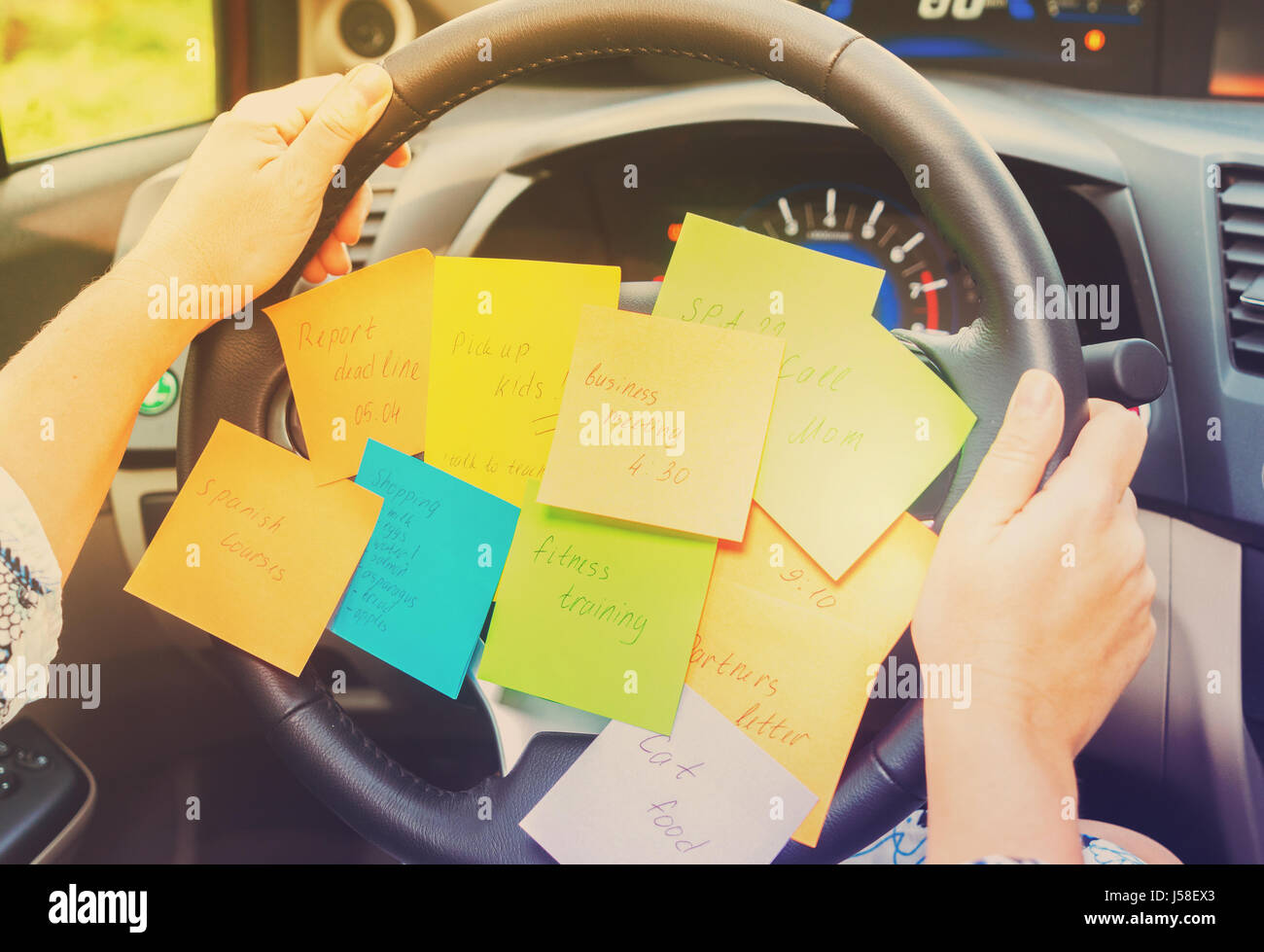 To do list in a car on driving wheel - busy day concept, retro toned ...