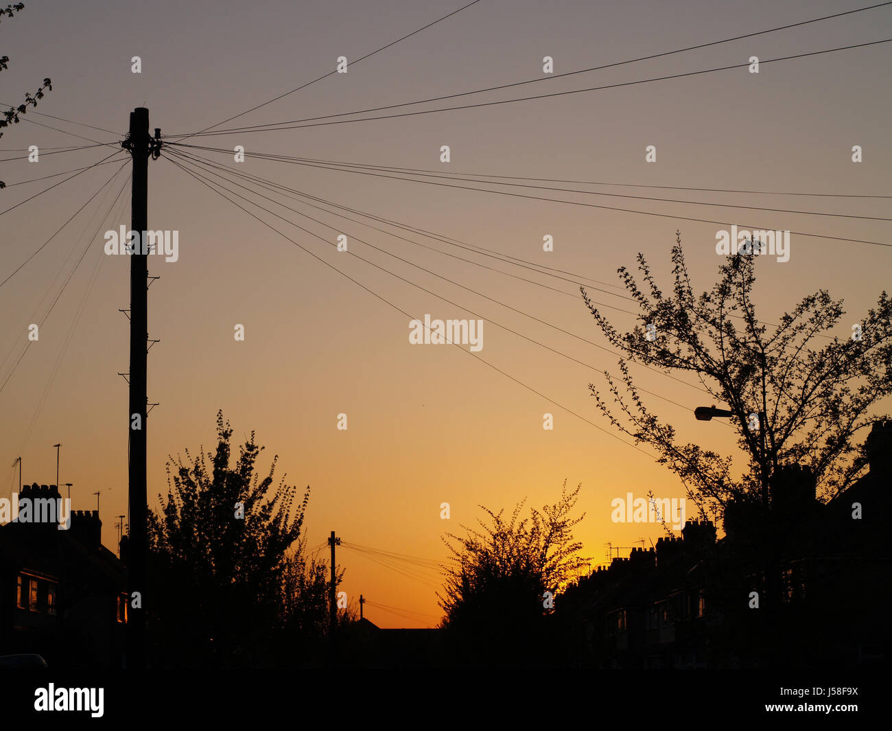 telegraph pole with orange sky Stock Photo - Alamy