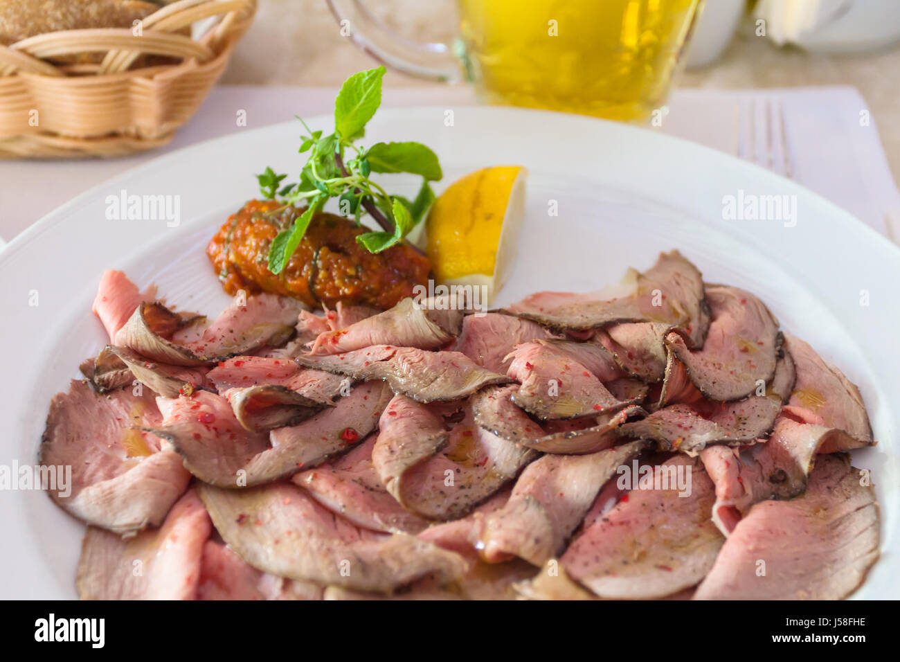 sliced roast beef close up on plate in italian restaurant Stock Photo ...