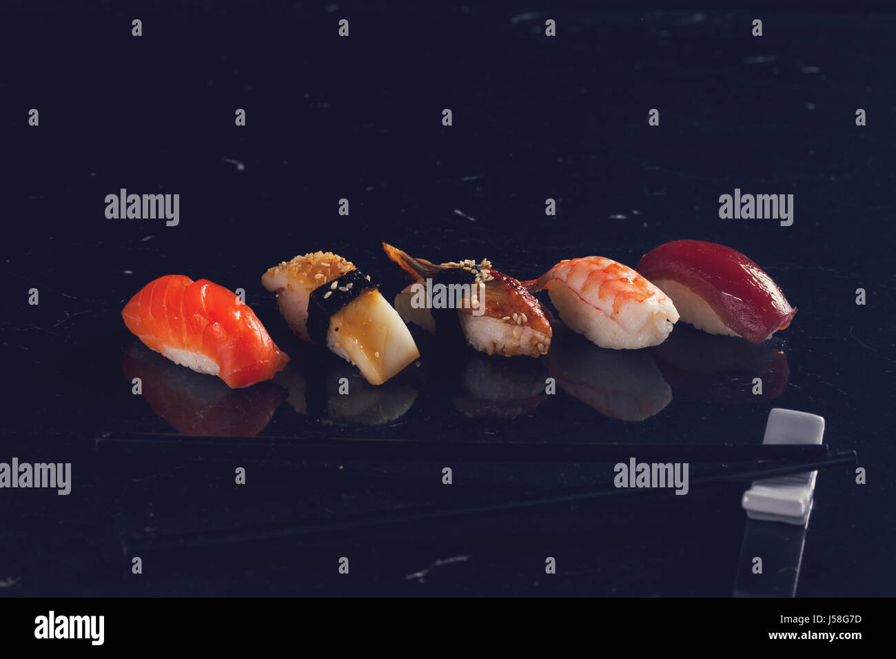 Row of japanese sushi dish on black background, retro toned Stock Photo ...
