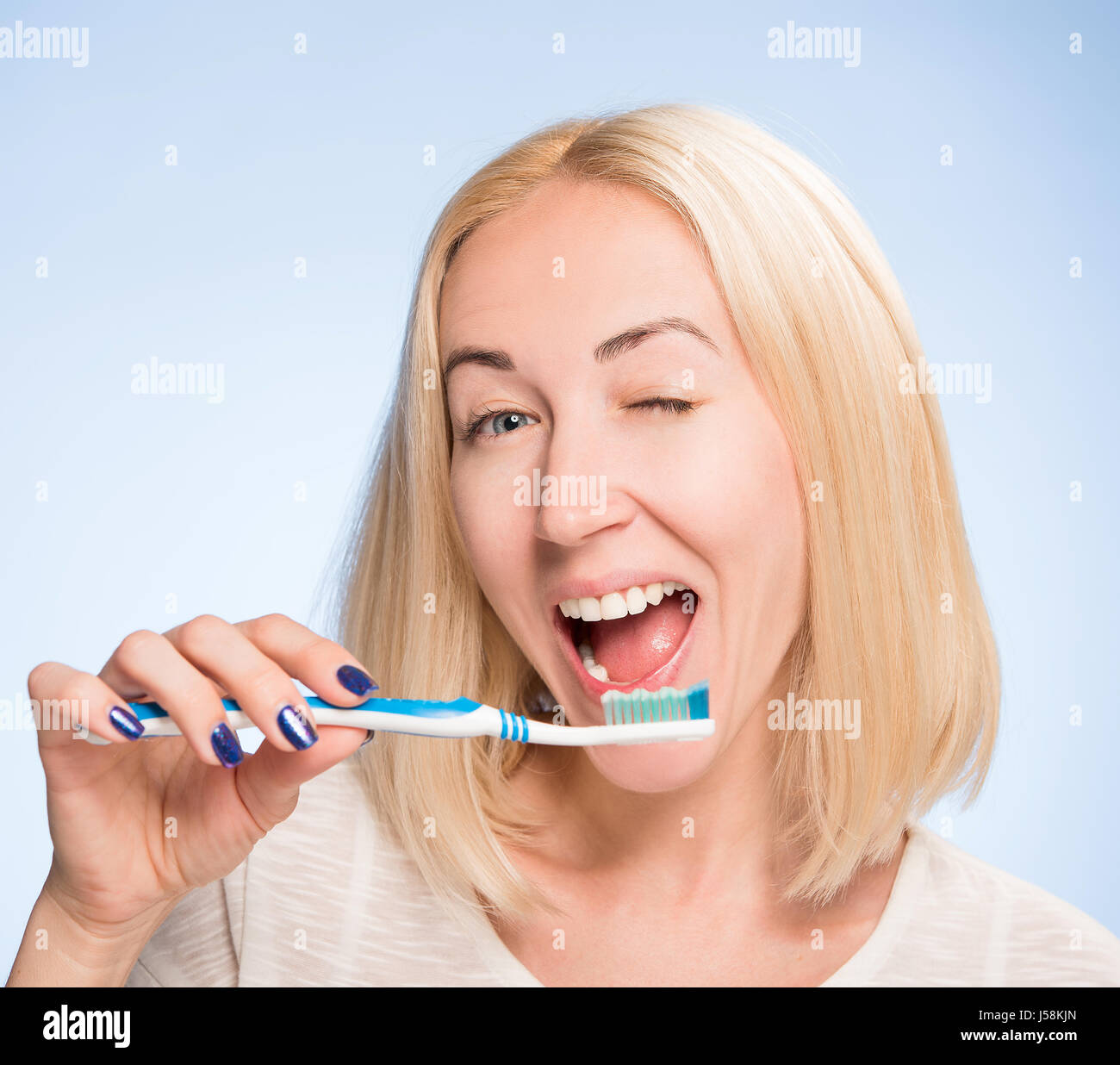 beautiful blonde cleans to a Shine teeth Stock Photo - Alamy