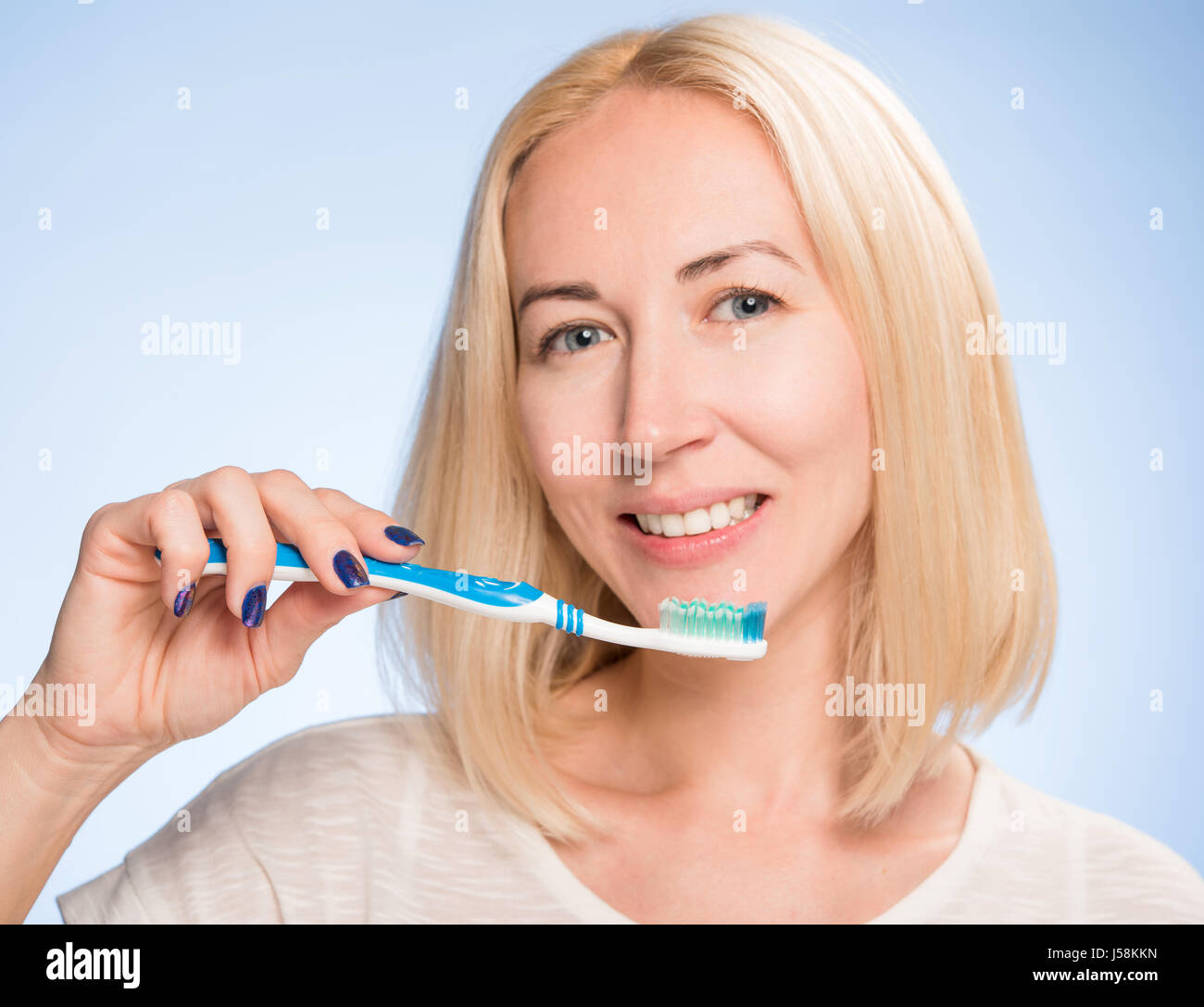 blonde cleans to a Shine teeth Stock Photo - Alamy