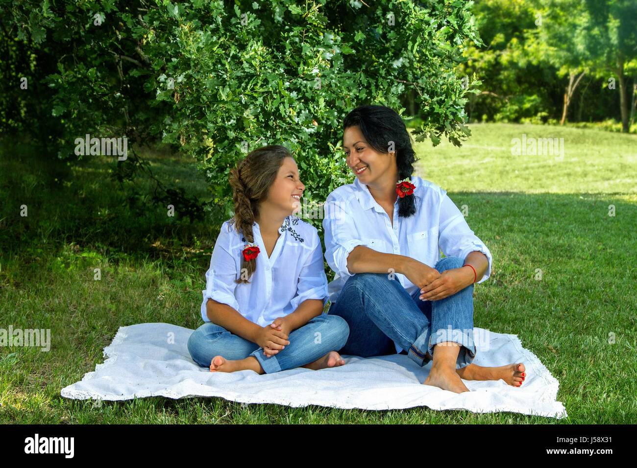 Woman sitting under oak tree hi-res stock photography and images - Alamy