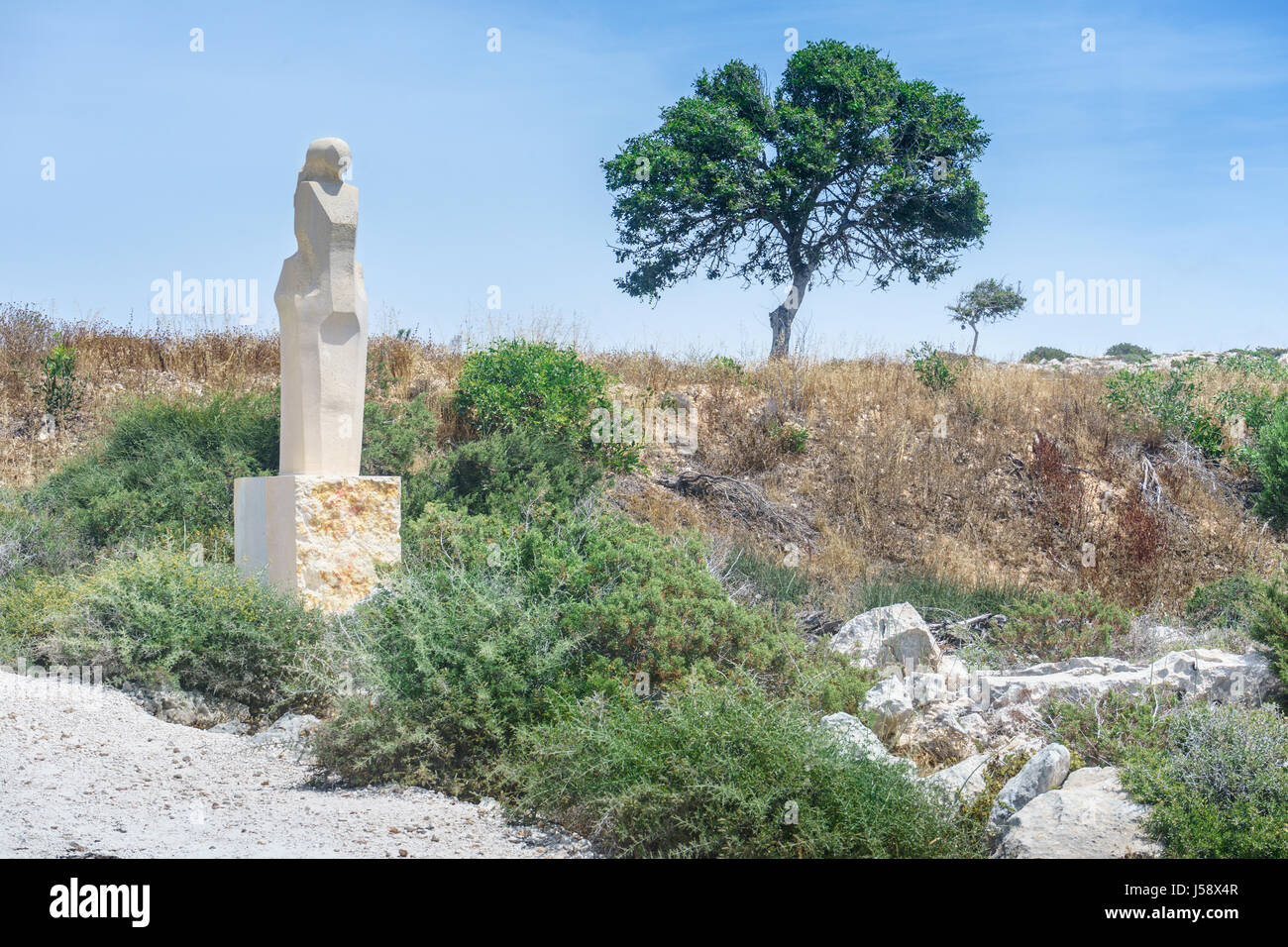 Sculpture of stone and beautiful tree in background Stock Photo - Alamy