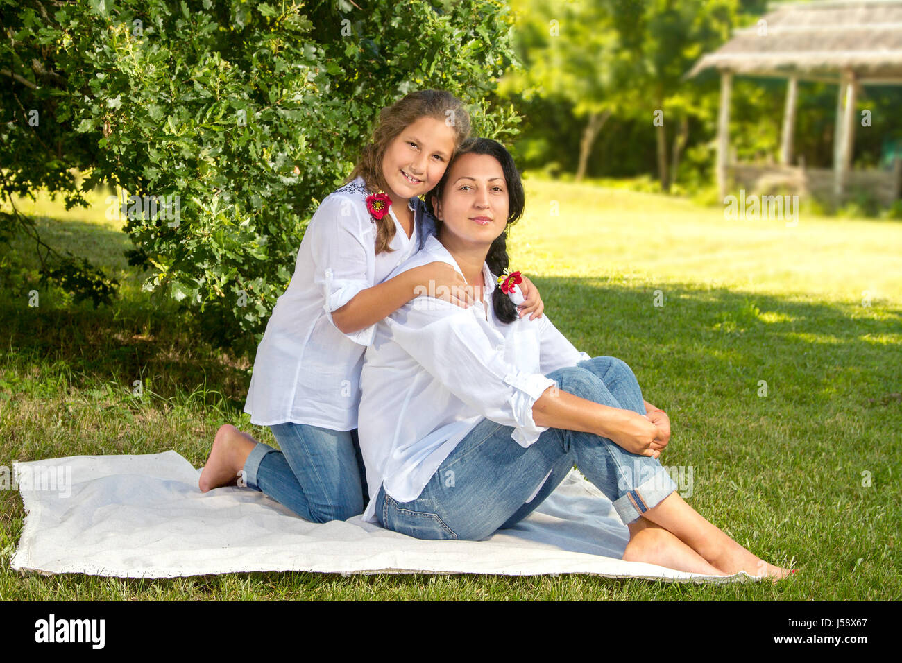 Woman sitting under oak tree hi-res stock photography and images - Alamy