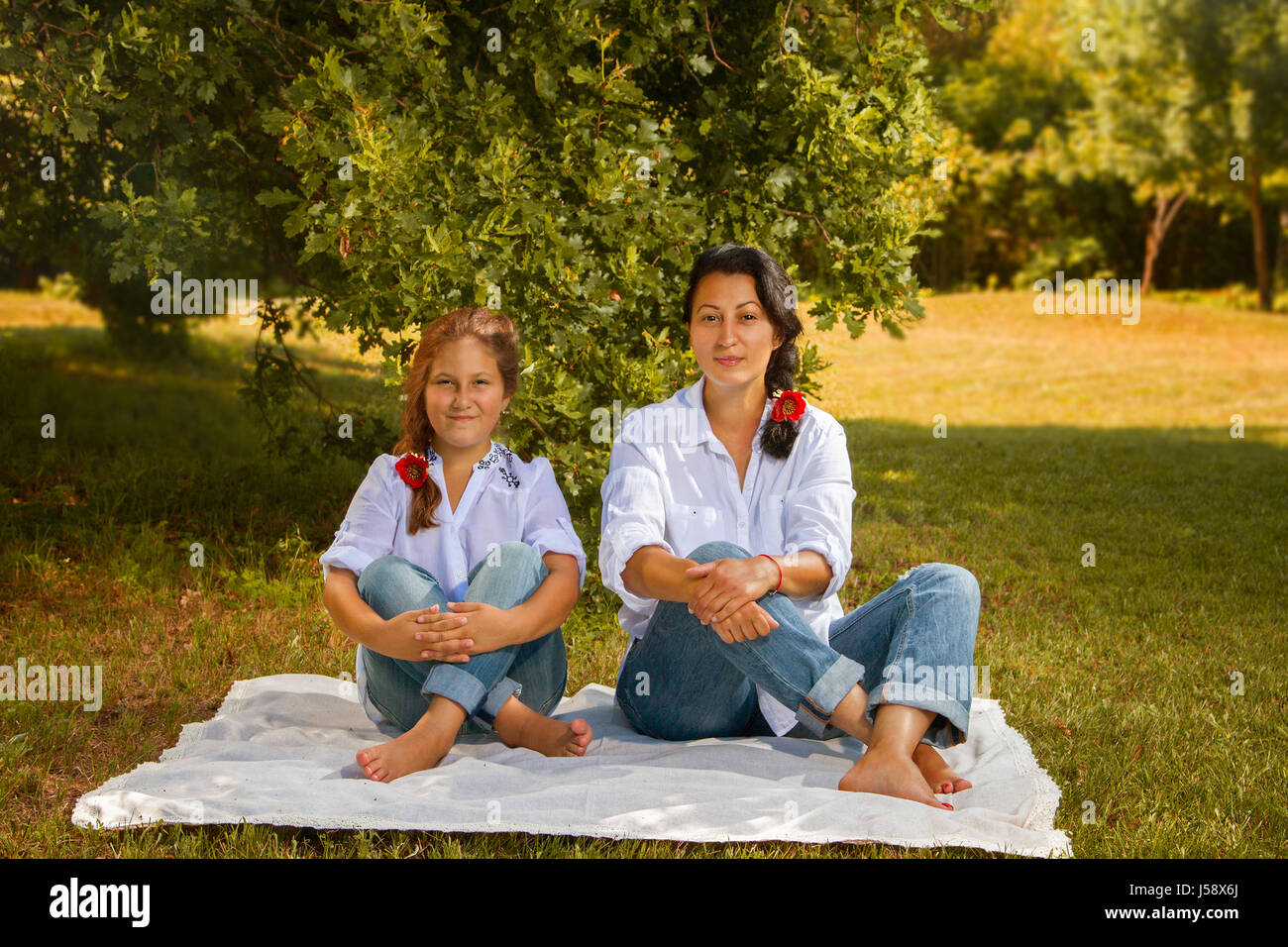 Woman sitting under oak tree hi-res stock photography and images - Alamy