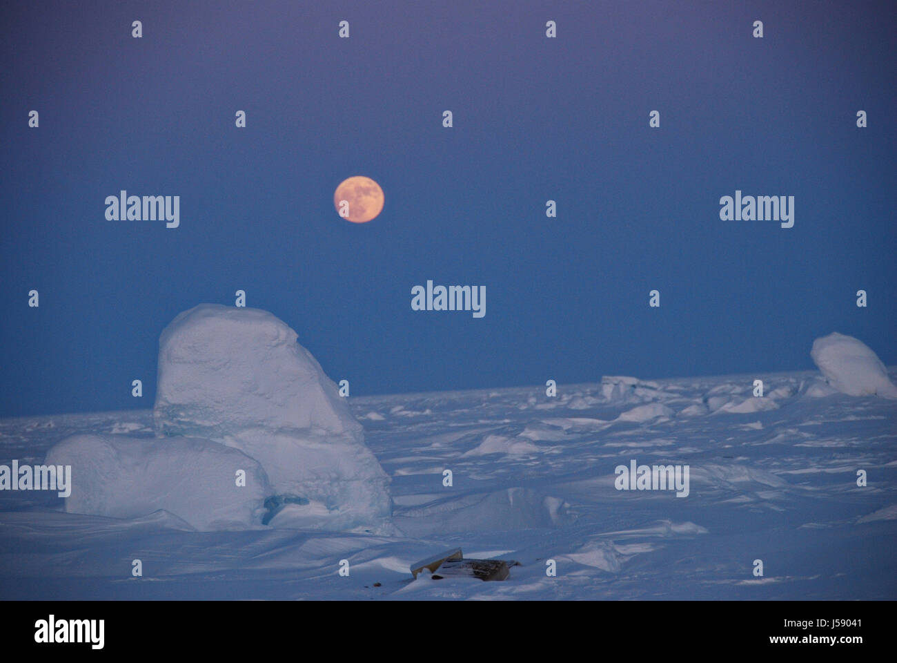 Snow and ice in the arctic landscape during a moon rise near the north ...