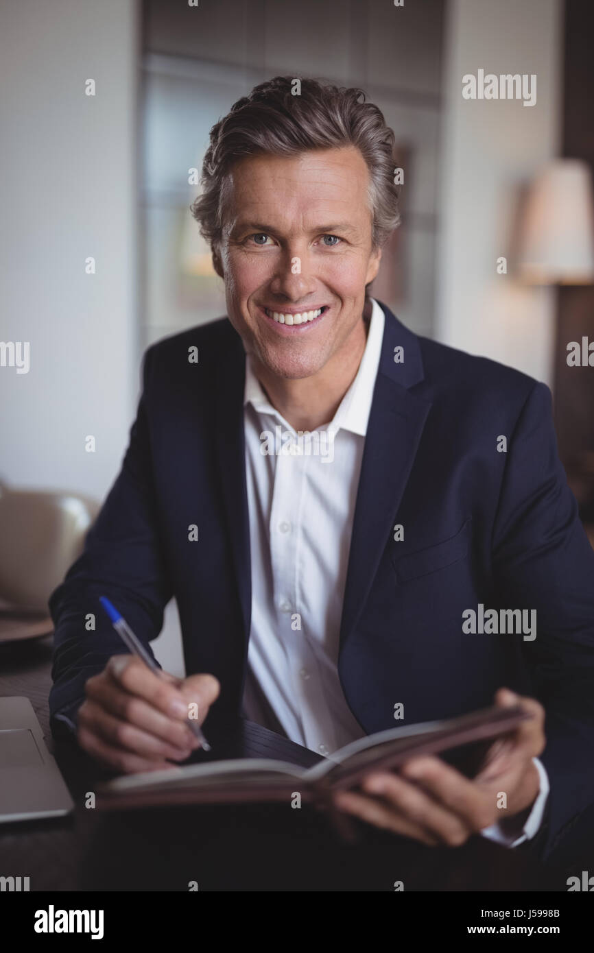 Mature adult writing kitchen table hi-res stock photography and images ...